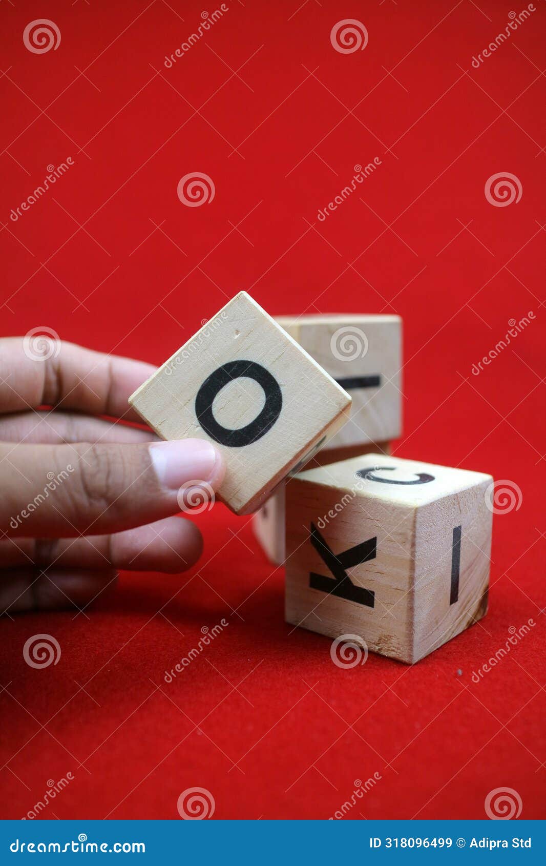 A Hand Holding Educational Stacking Cube Toy Made of Wood with Numbers ...
