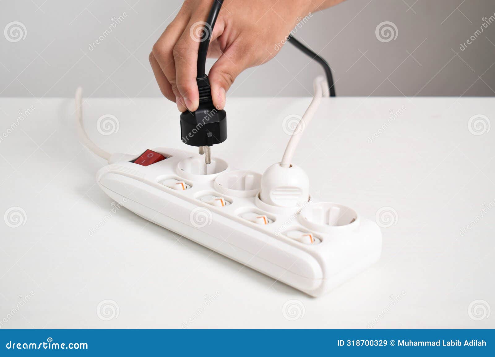 Hand Holding Electric Plug, Multiple Socket with Connected Plugs. Stock ...