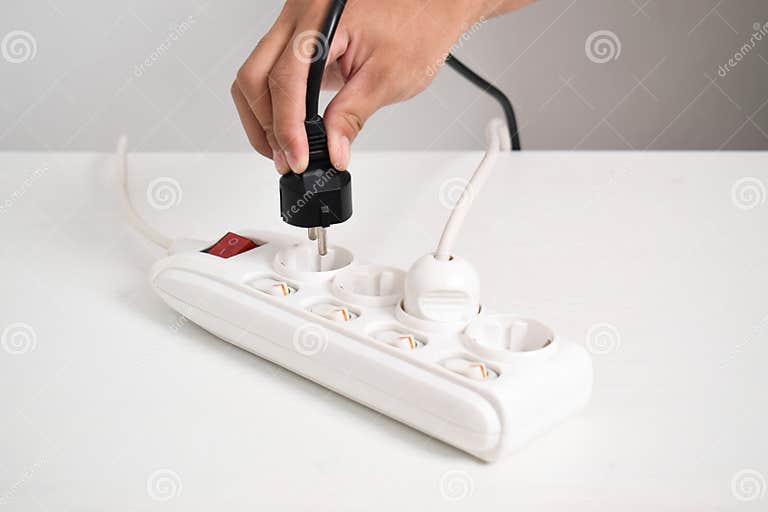 Hand Holding Electric Plug, Multiple Socket with Connected Plugs. Stock ...