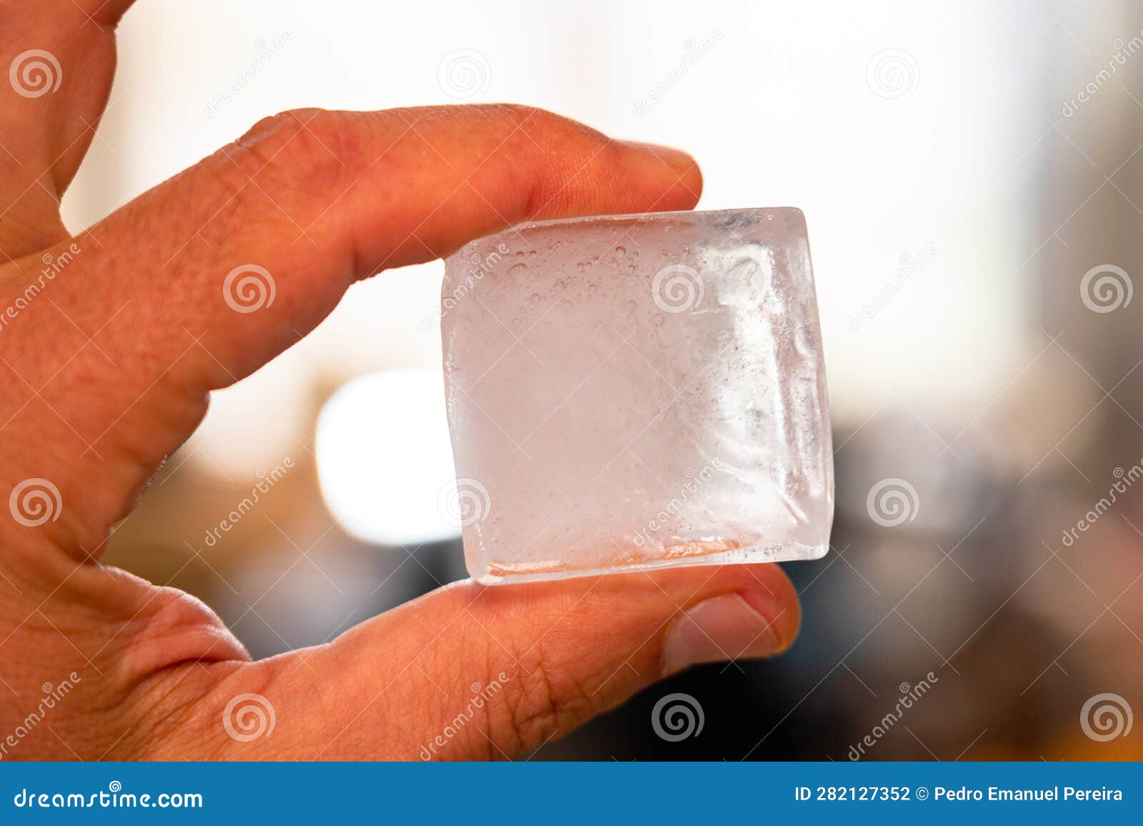 Hand Holding between the Fingers an Ice Cube, Solid Water Stock Photo ...