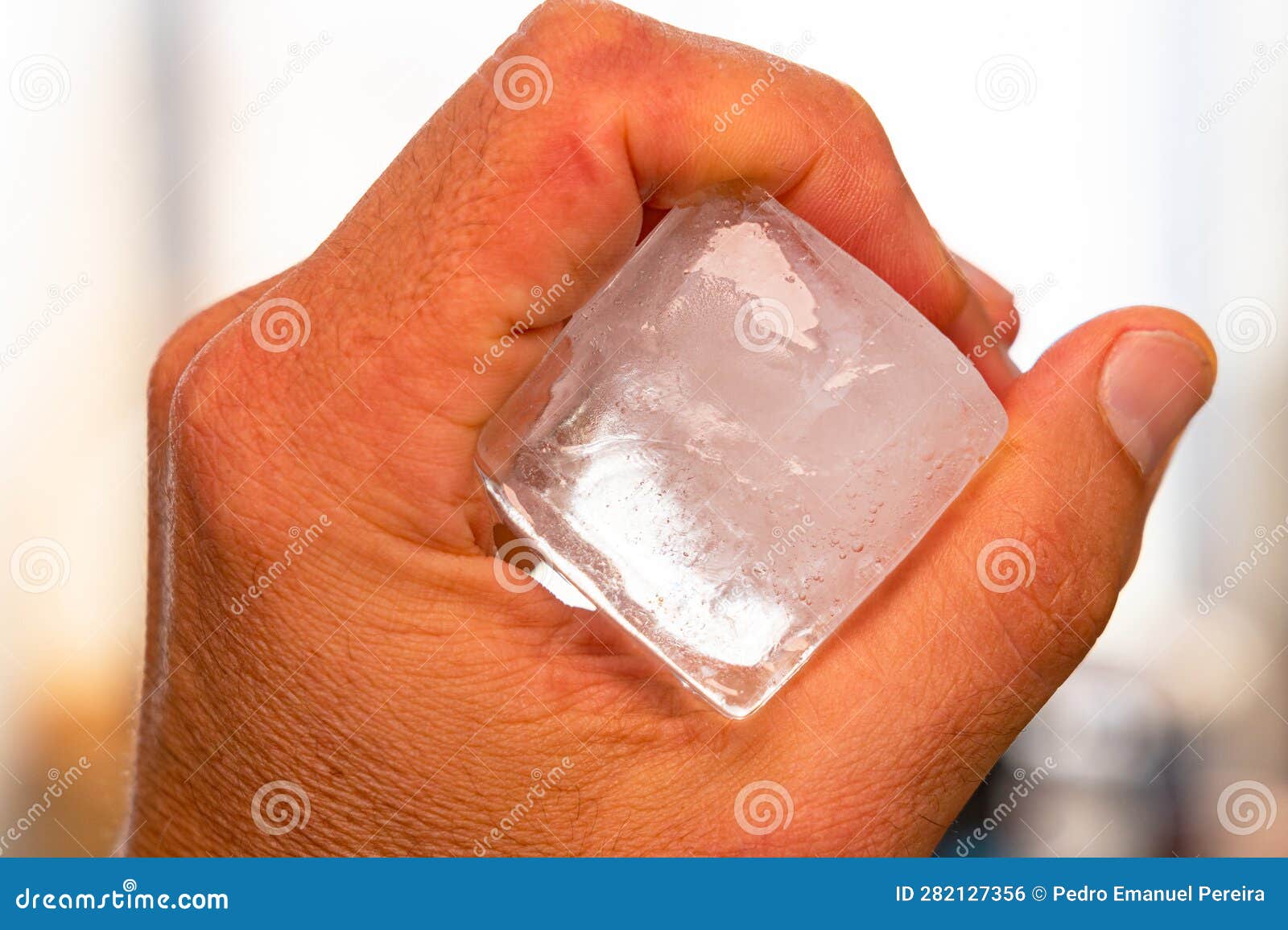 Hand Holding between the Fingers an Ice Cube, Solid Water Stock Photo ...