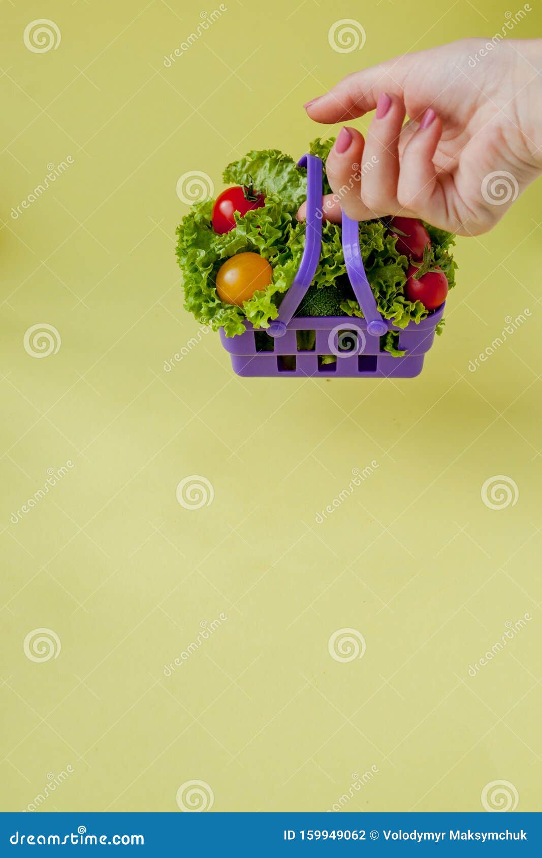 Hand Holding Fresh Vegetables in Basket on Yellow Background Stock ...