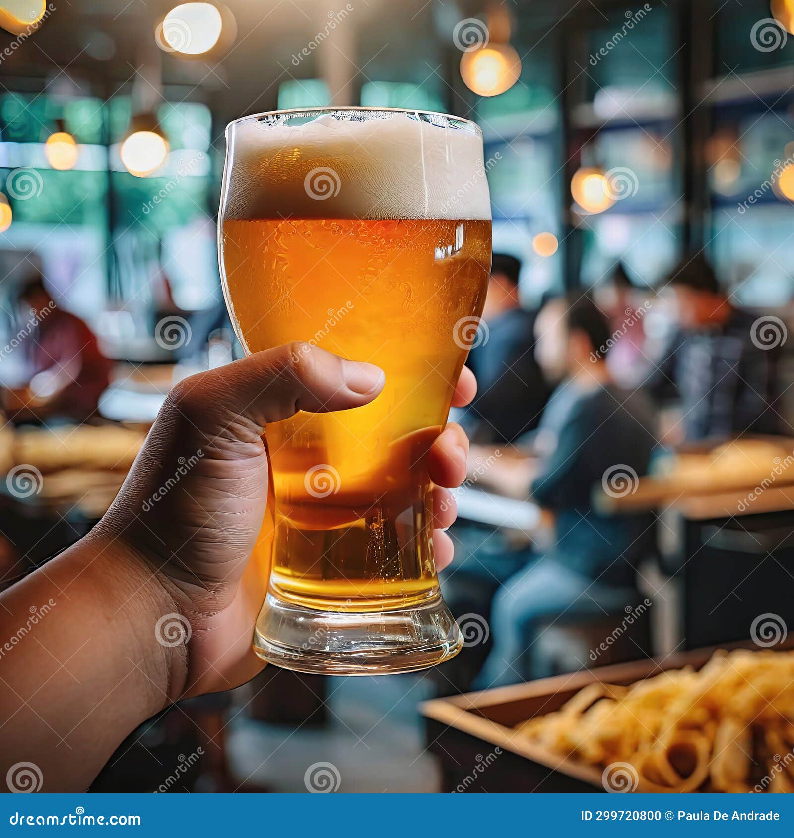 Hand Holding a Glass of Beer with Blurred Bar Background Stock ...