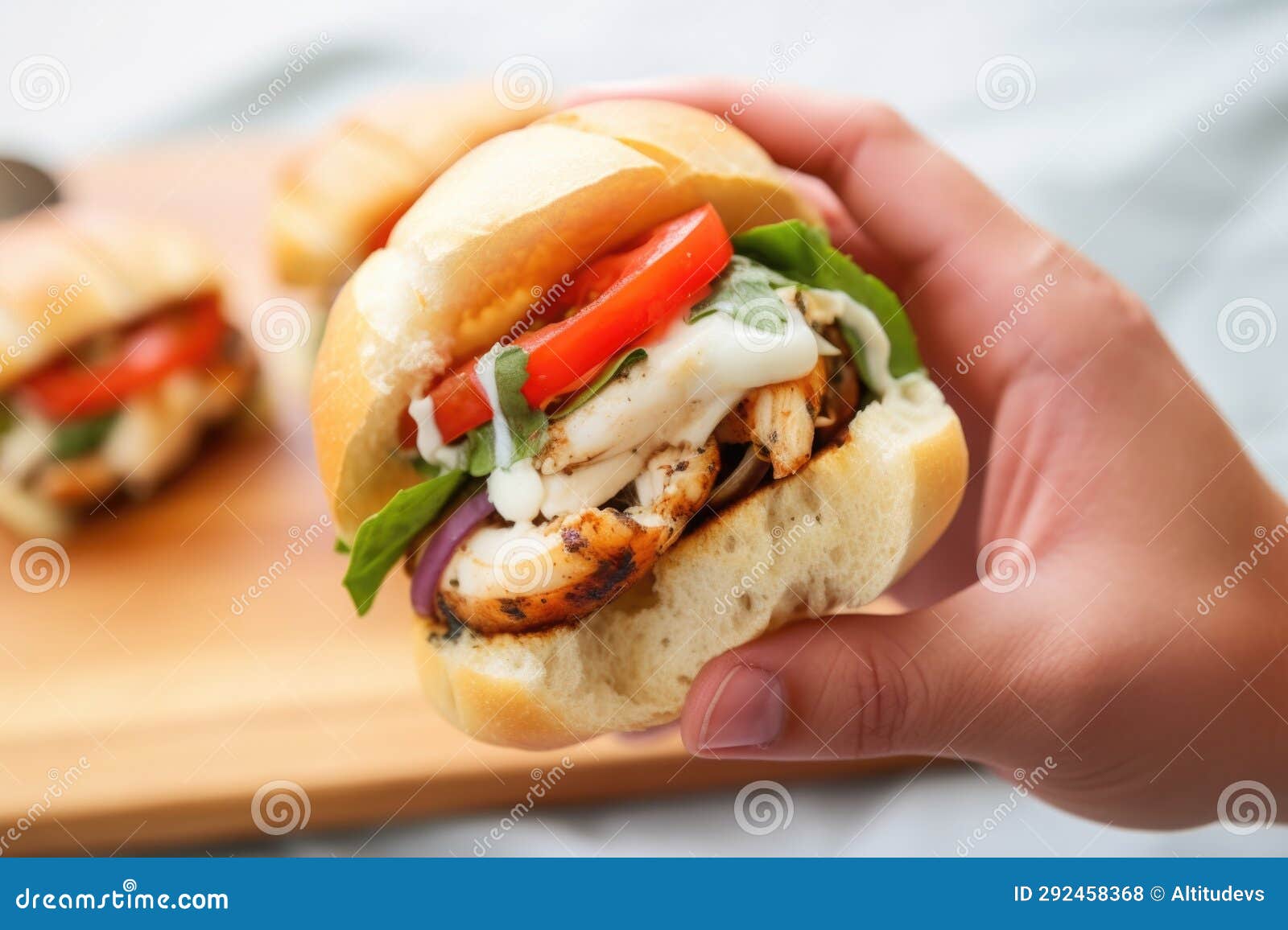 Hand Holding a Grilled Calamari Ring in a Slider Bun Stock Illustration ...
