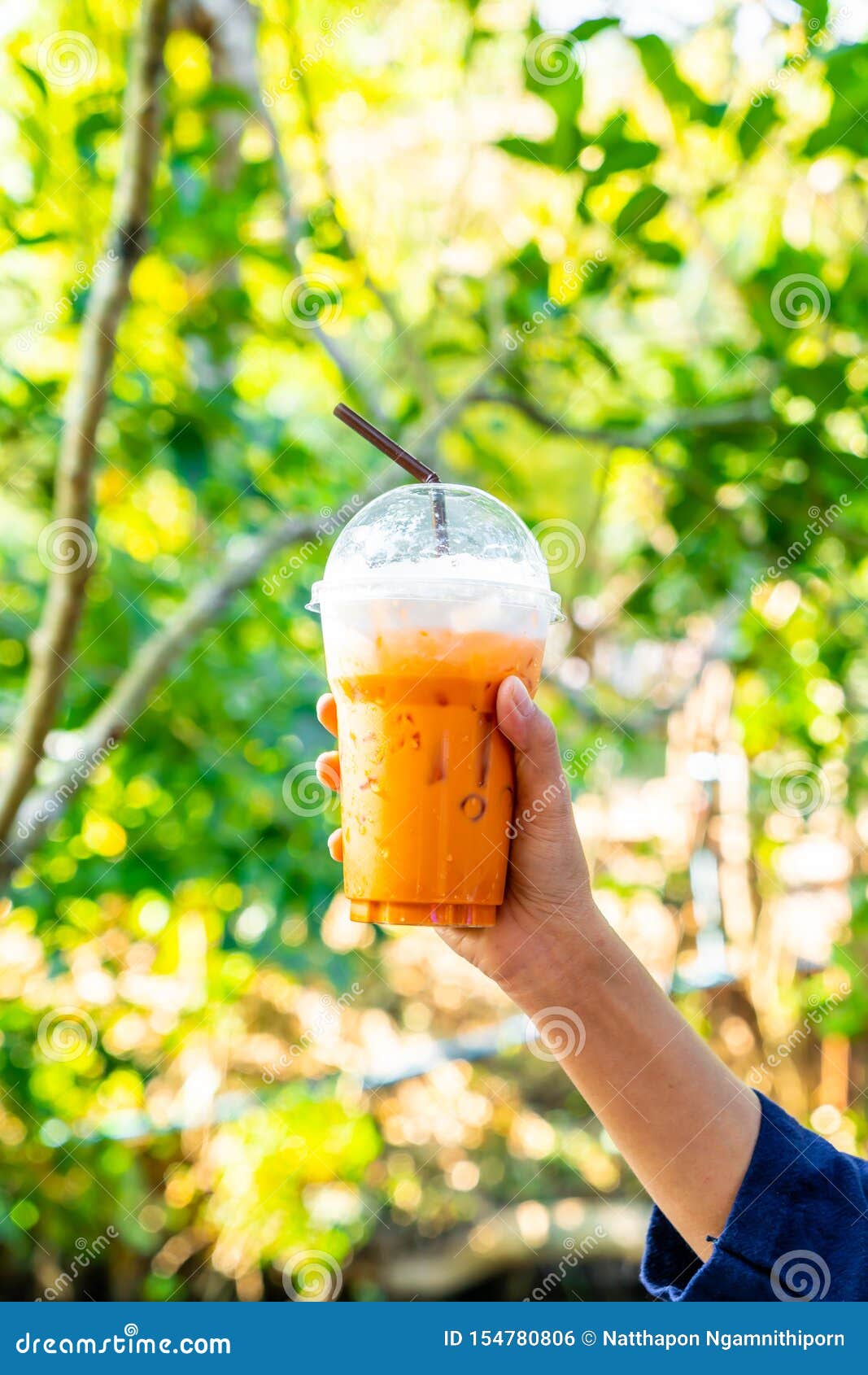 Hand Holding Iced Thai Milk Tea Stock Photo - Image of space, dessert ...
