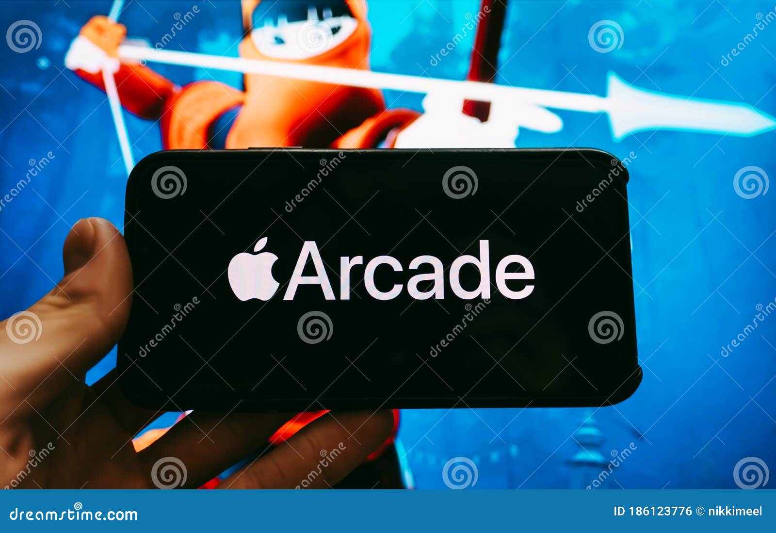 Hand Holding the IPhone with Apple Arcade Logo on the Screen Editorial ...