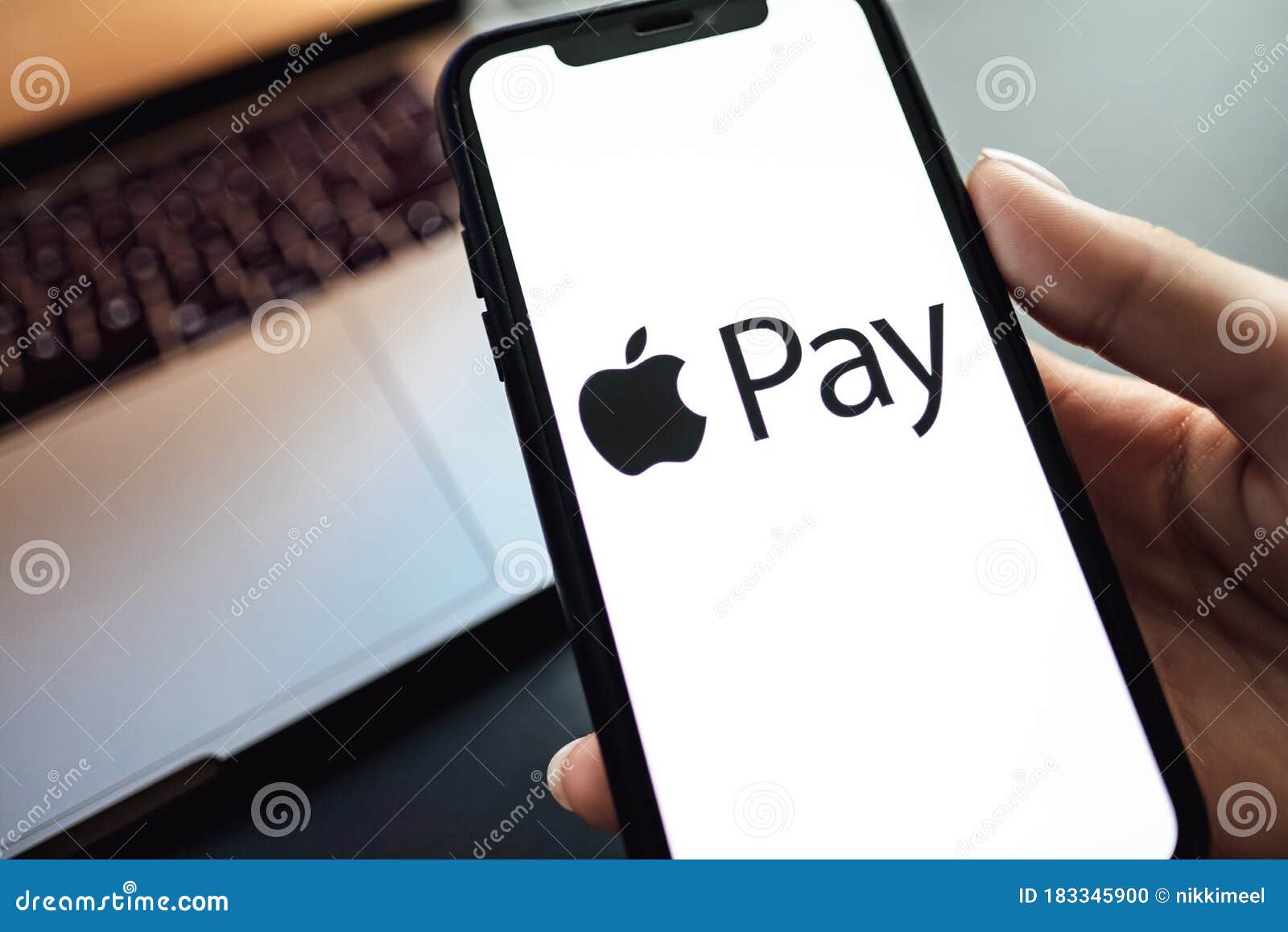 Hand Holding the IPhone X with Apple Pay Logo on the Screen. Editorial ...