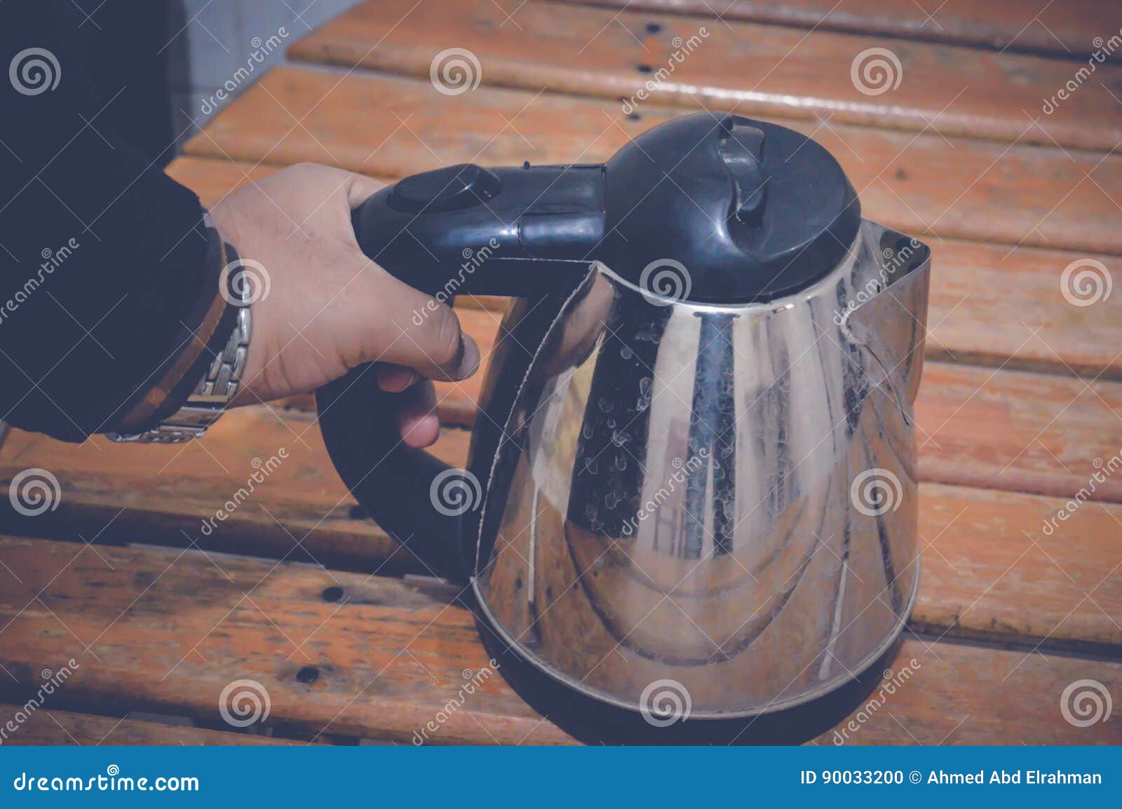 Hand holding kettle stock photo. Image of utensil, hand - 90033200