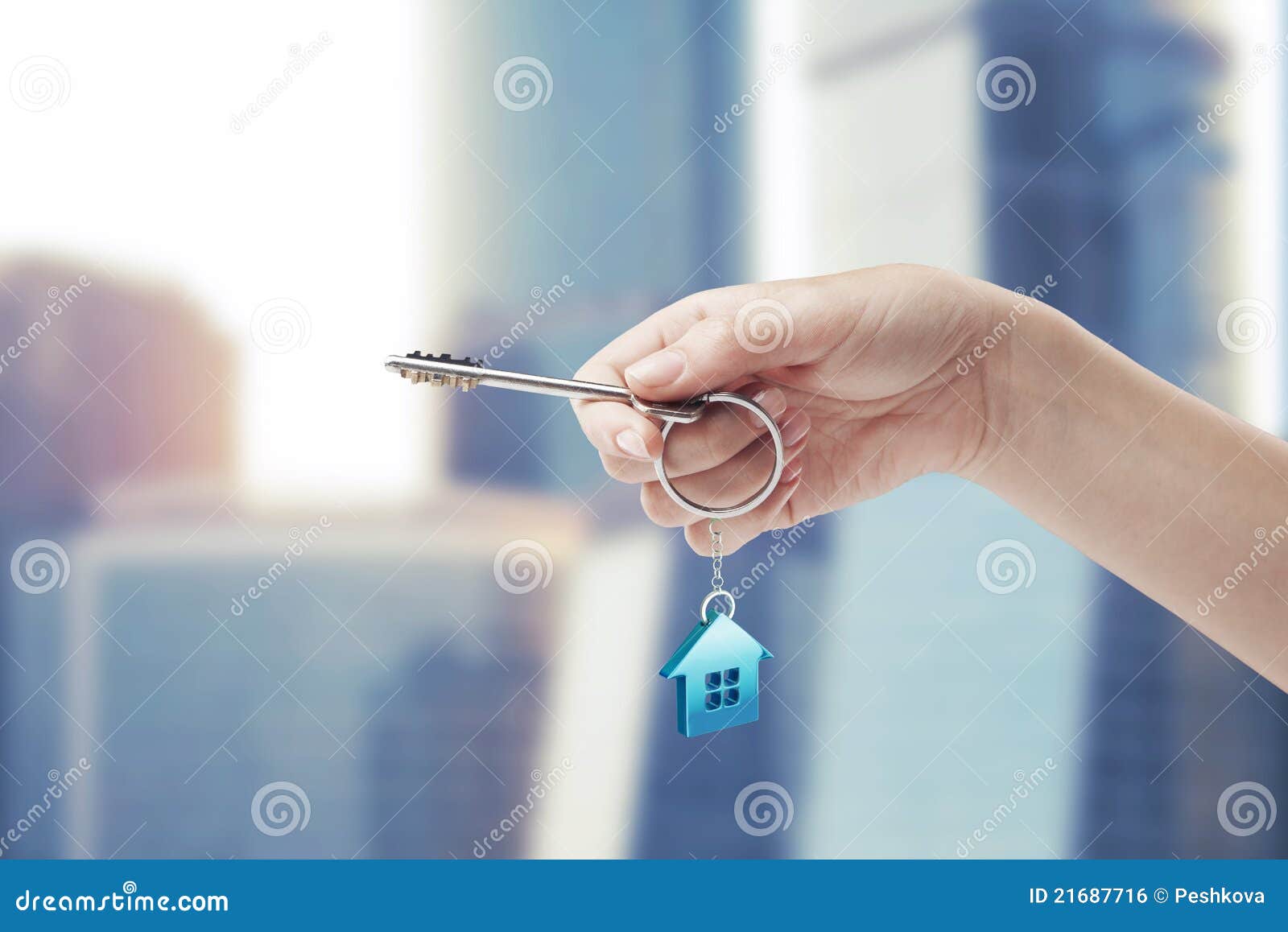 Hand Holding Key with a Keychain Stock Photo - Image of blue, concept ...