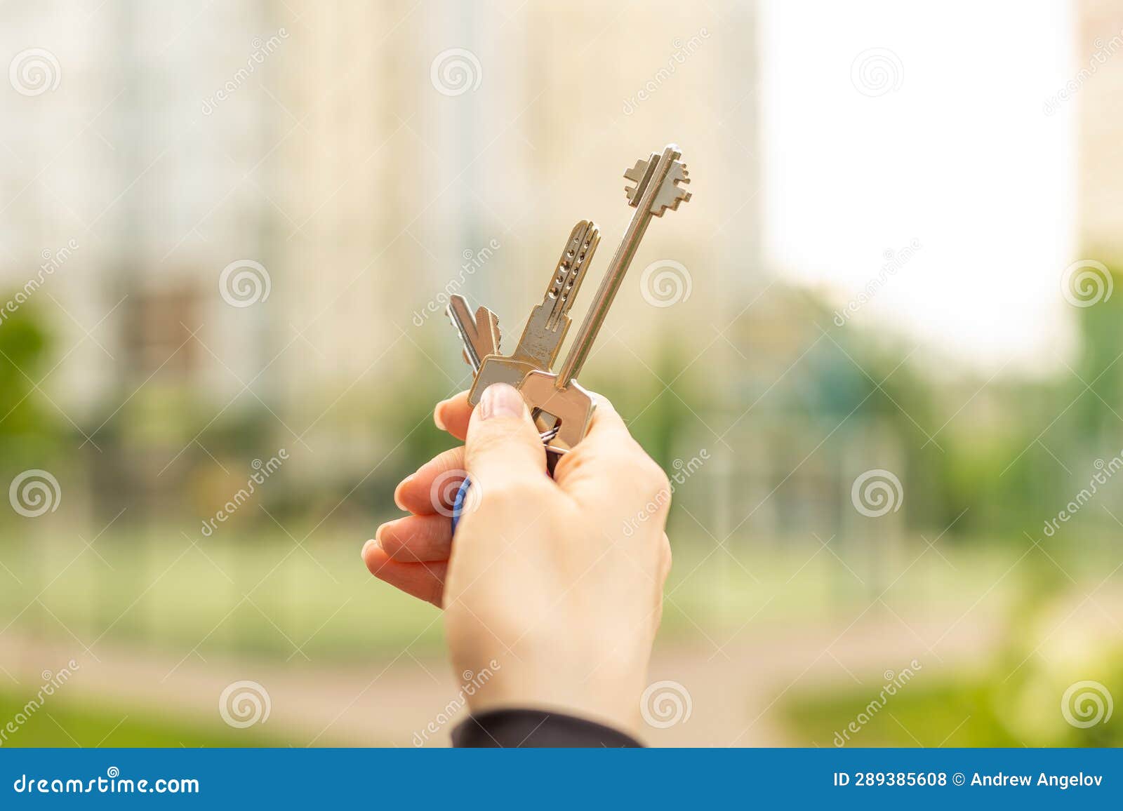 Hand Holding Keys in Front of Building Stock Photo - Image of dream ...