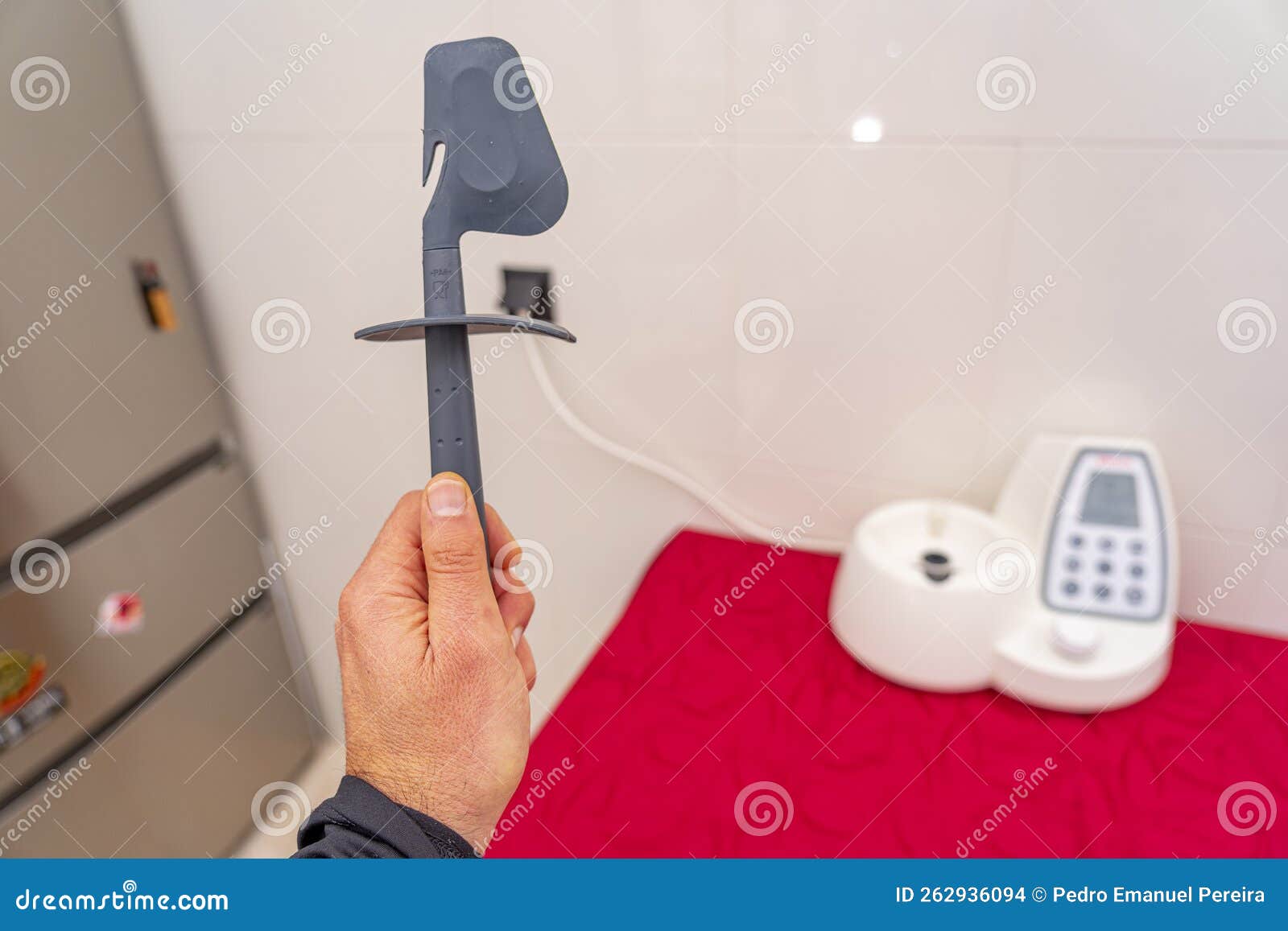 Hand Holding Kitchen Robot Spatula With Respective Machine In ...