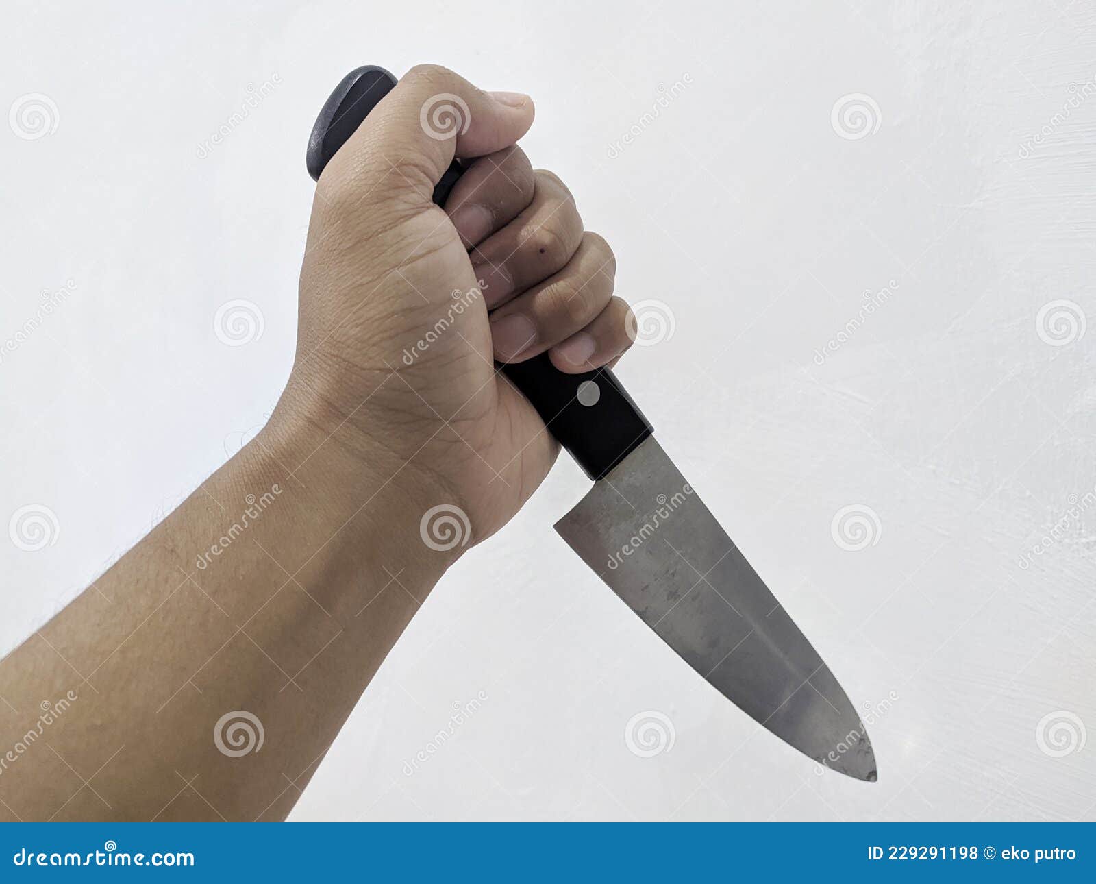A hand holding a knife stock photo. Image of holding - 229291198