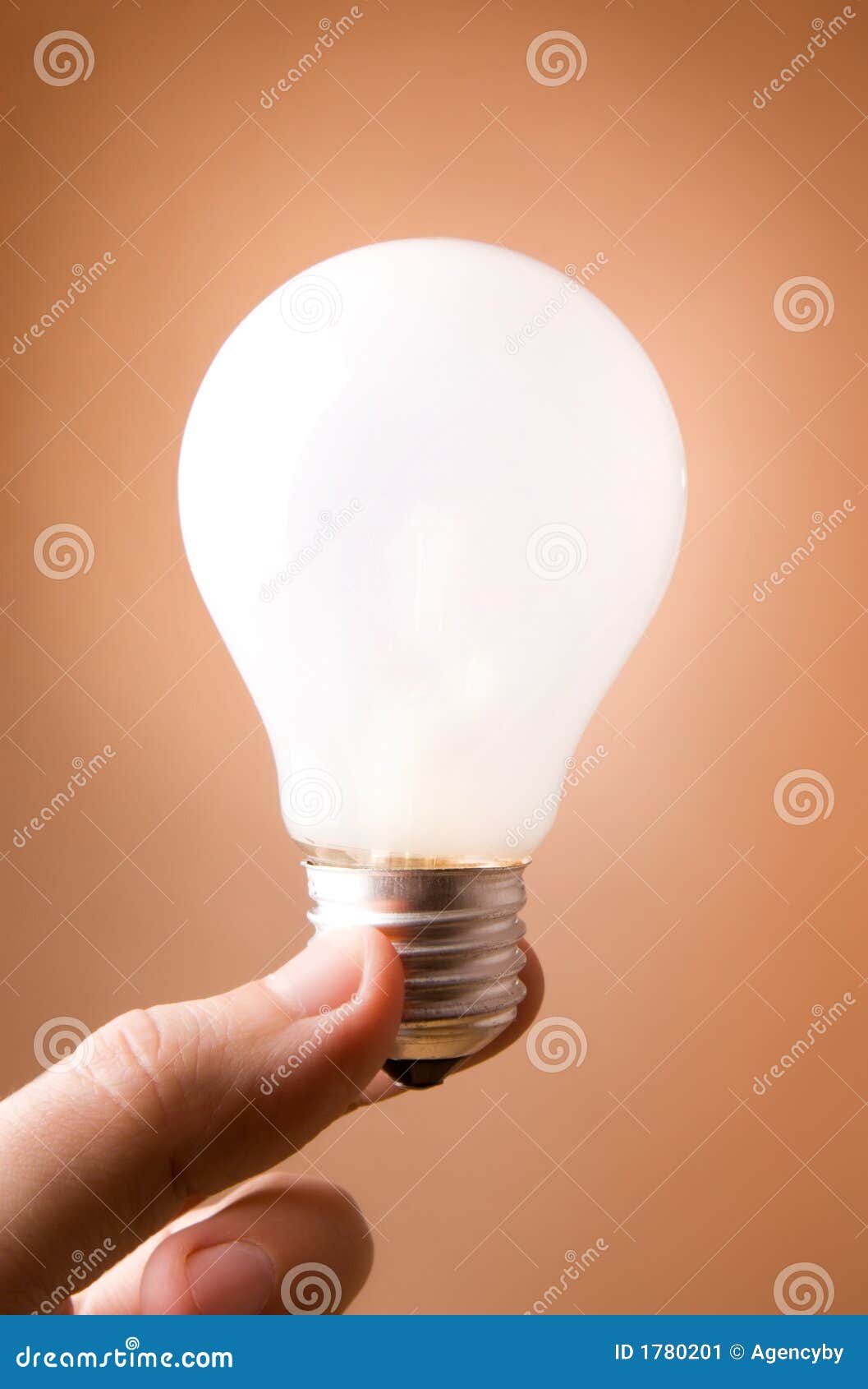 Hand Holding Light Bulb on the Beige Background Stock Image - Image of ...