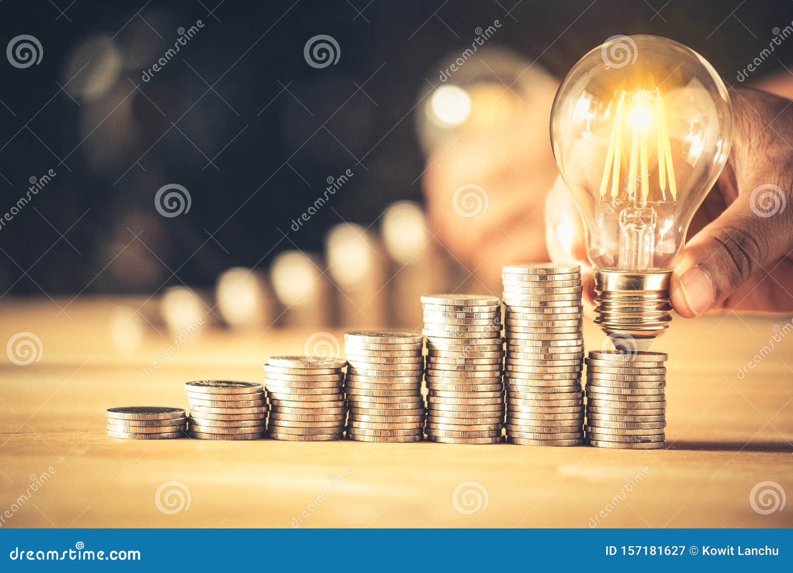 Hand Holding a Light Bulb with Coins Stack. Creative Ideas for Saving ...