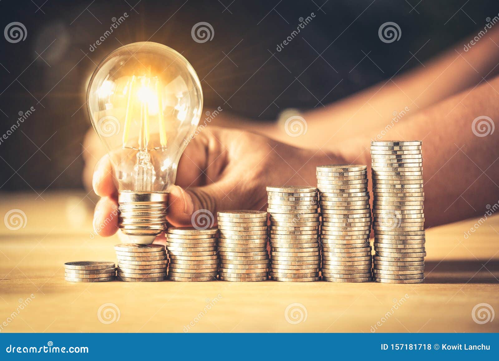 Hand Holding a Light Bulb with Coins Stack. Creative Ideas for Saving ...