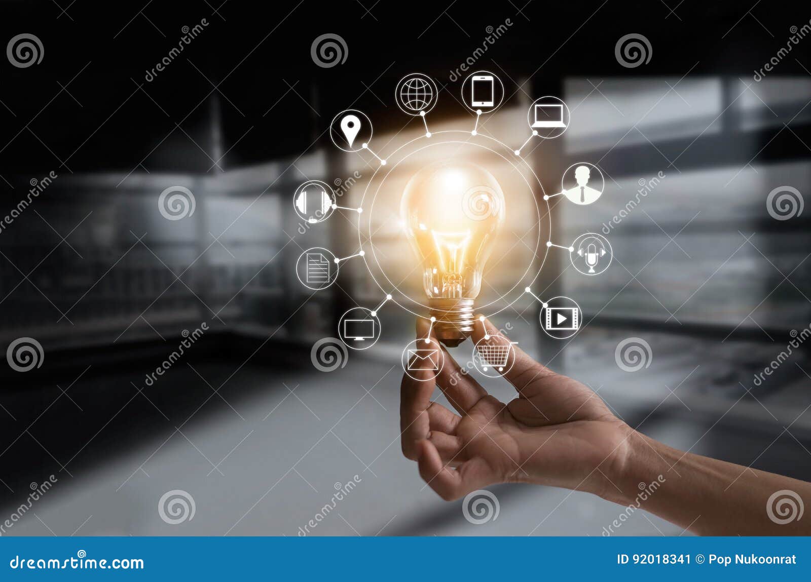 Hand Holding Light Bulb with Icons Multimedia and Customer Network ...