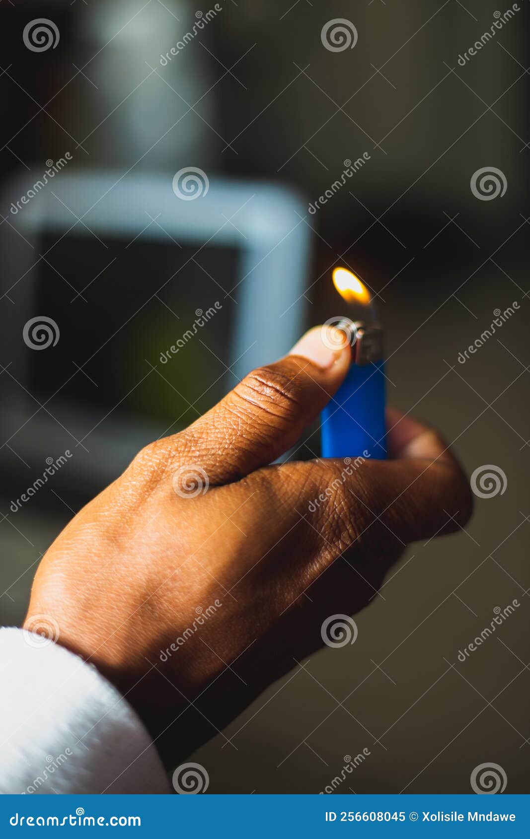 Hand holding a lighter stock image. Image of blue, limb - 256608045