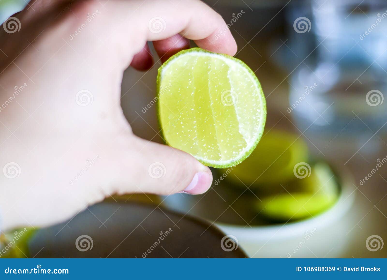 Hand holding lime wedge stock image. Image of macro - 106988369