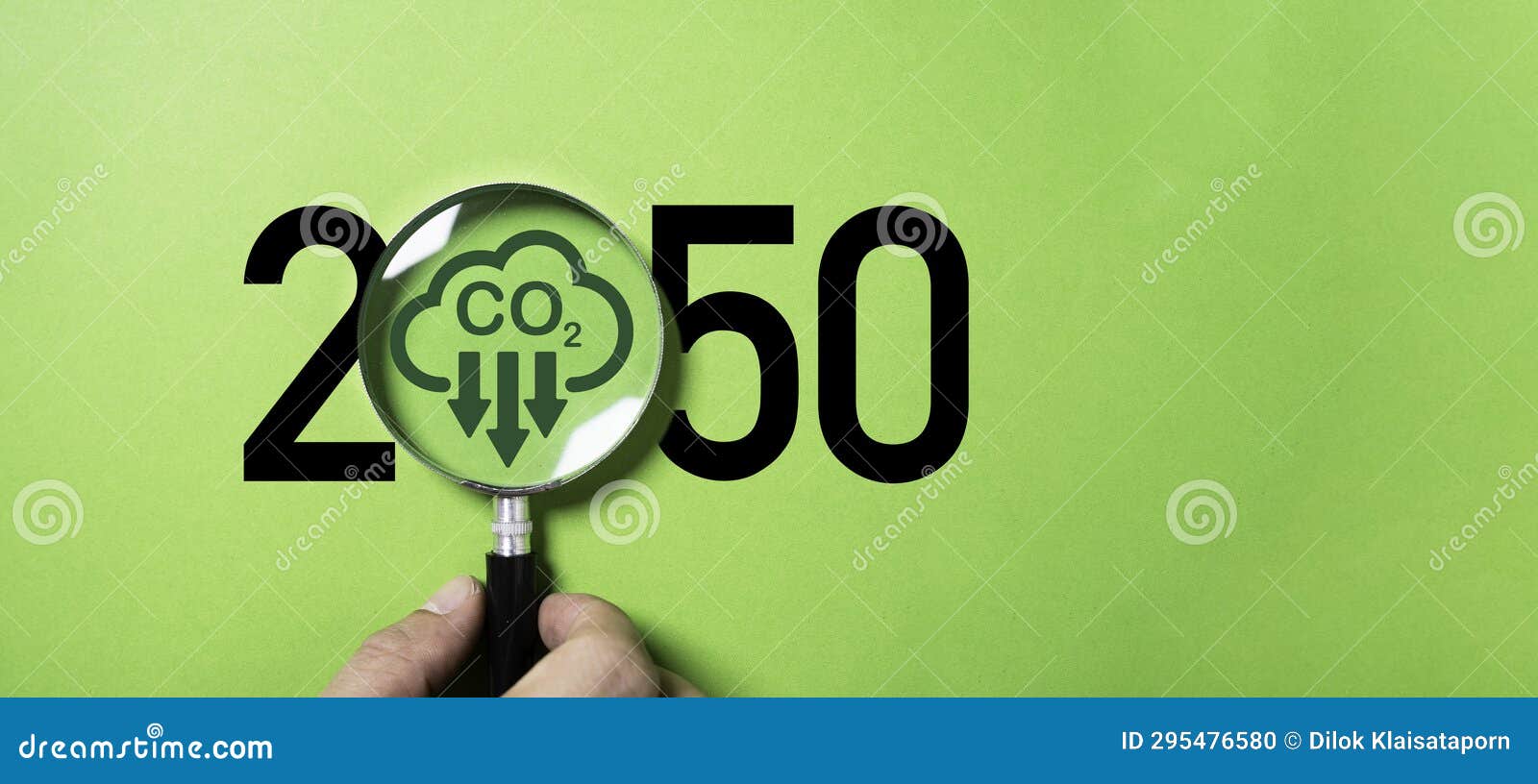 Hand Holding Magnifier Glass with CO2 Reduction and 2050 Year for Decrease CO2 , Carbon ...