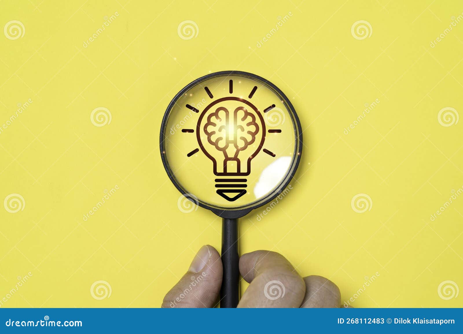 Hand Holding Magnifier Glass Inside of Drawing of Glowing Light Bulb ...