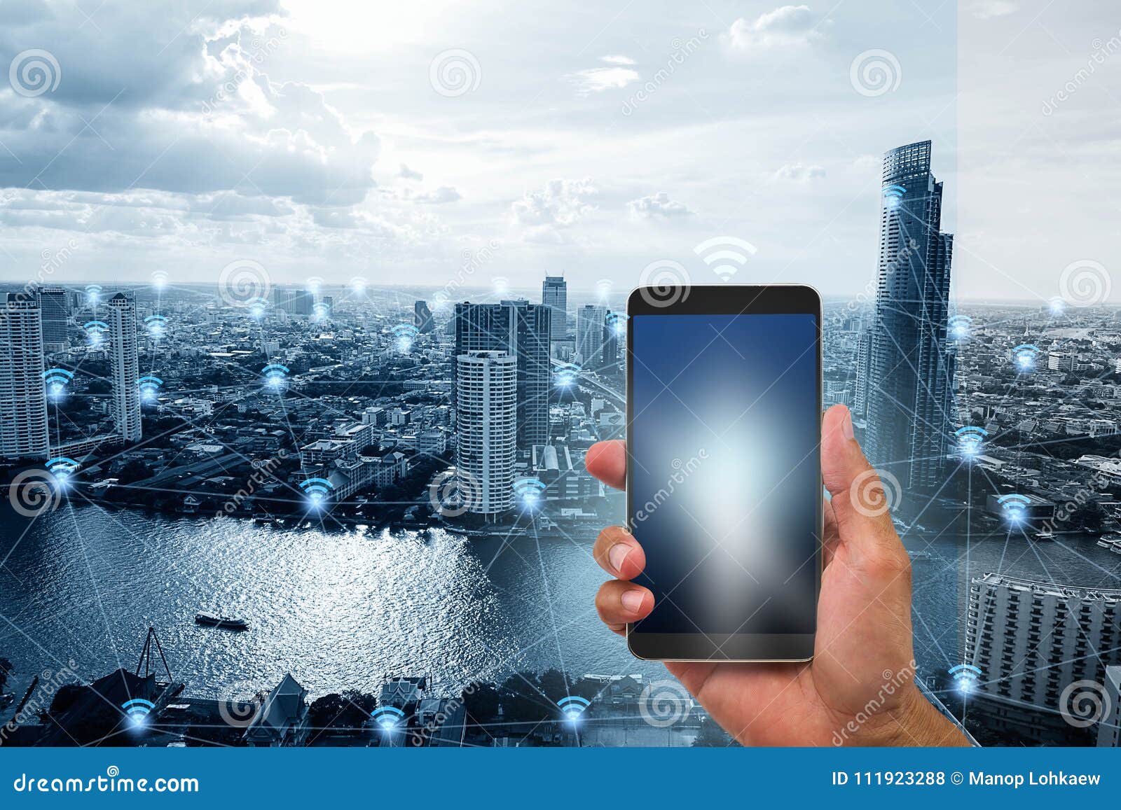 Hand Holding Mobile Phone on Blue Tone Smart City with Wifi Network ... Hand Holding Mobile Phone on Blue Tone Smart City with Wifi Network ...