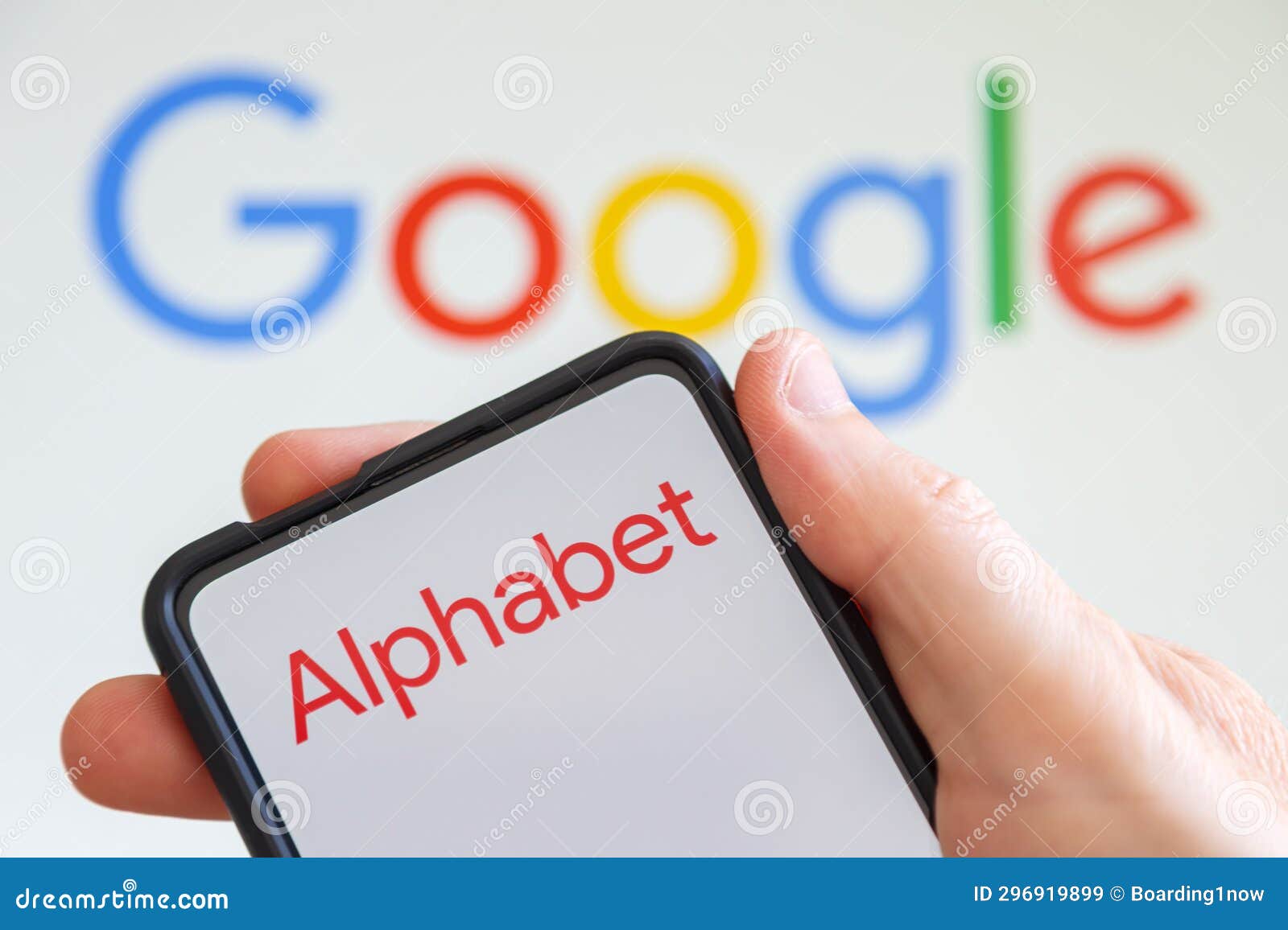 Hand Holding a Mobile Phone with Google and Alphabet Logo of the ...