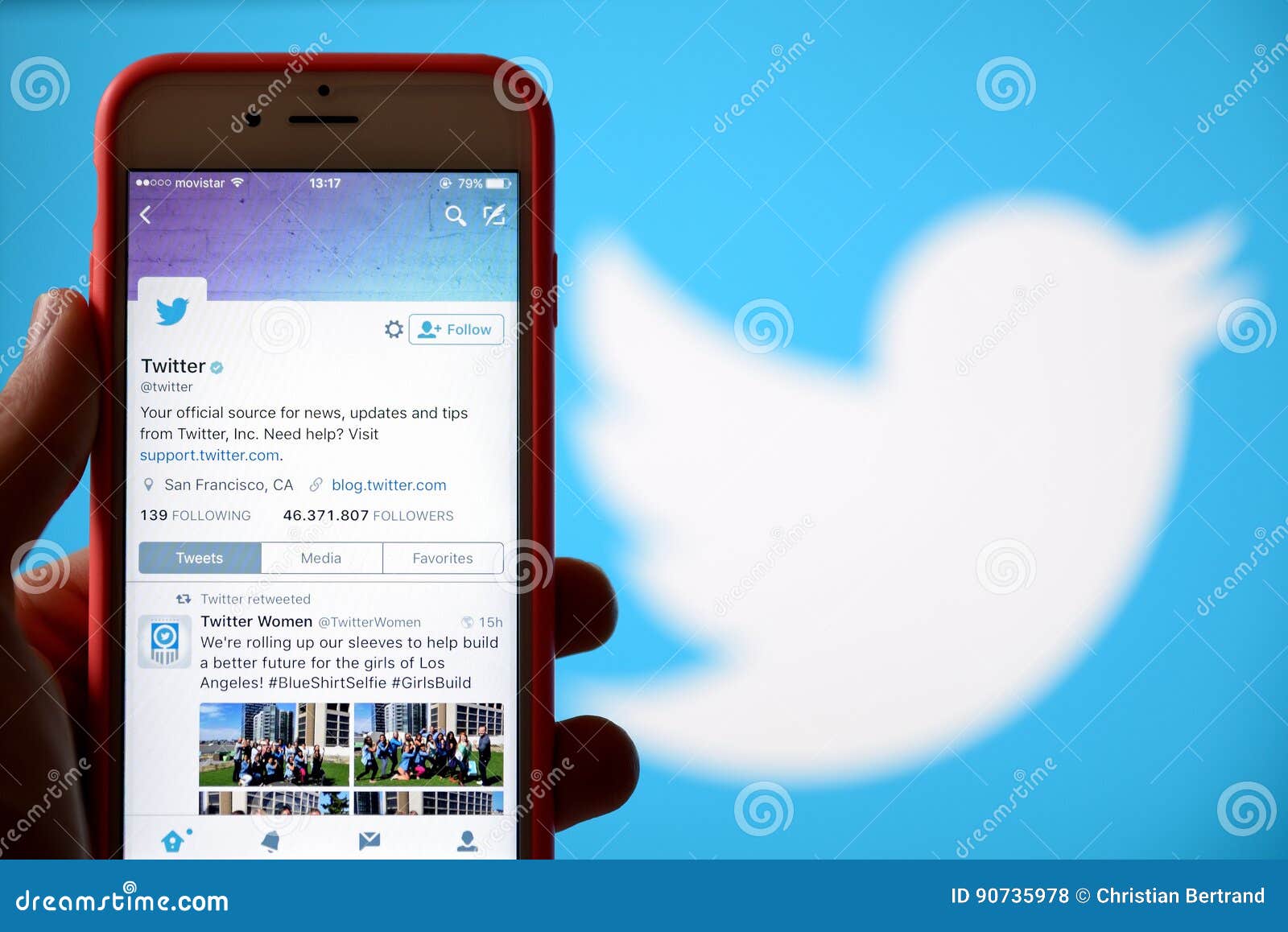 Hand Holding a Mobile Phone and Using the Social Network Twitter ...