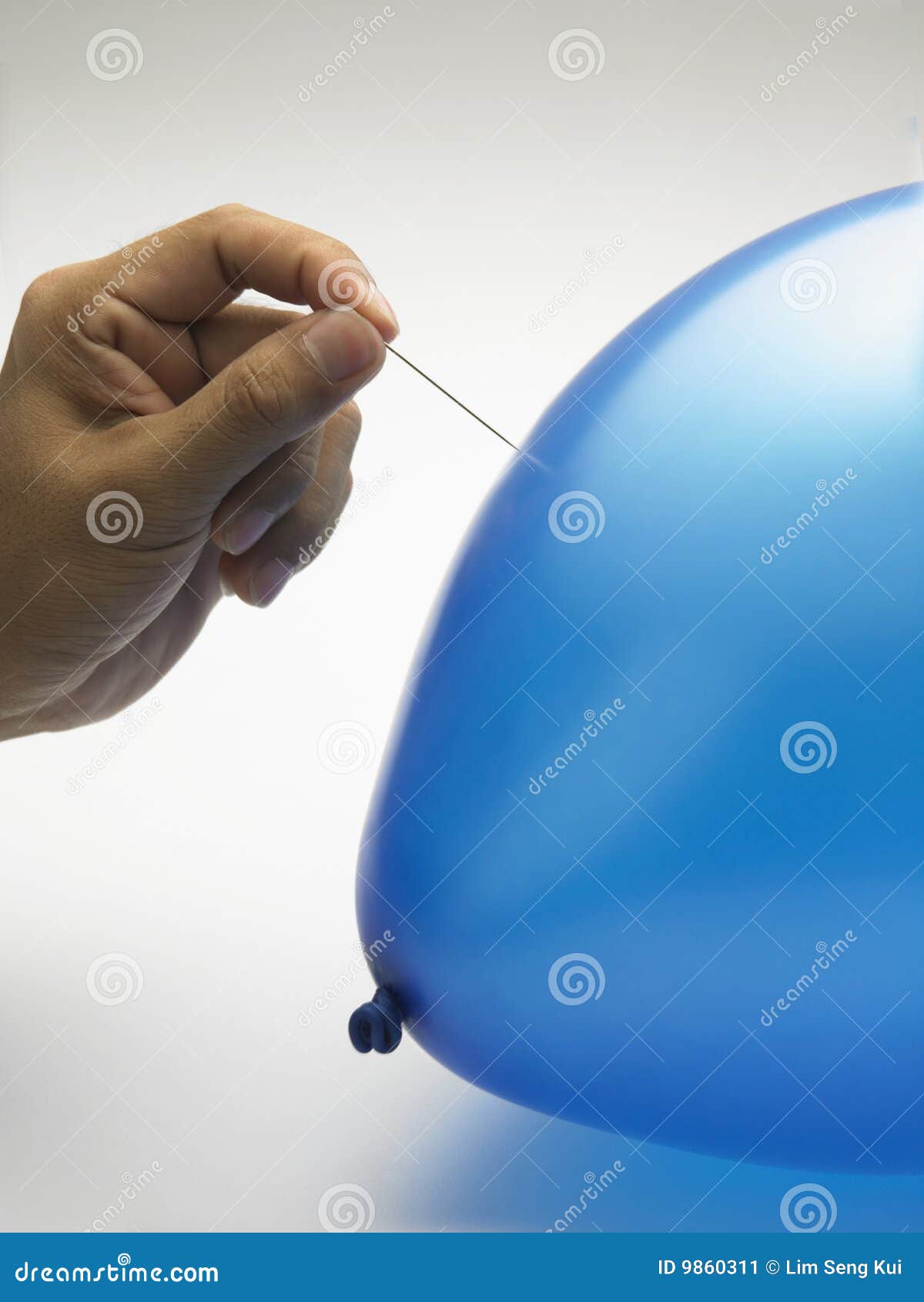 Hand Holding a Needle Closely To the Balloon Stock Image - Image of ...