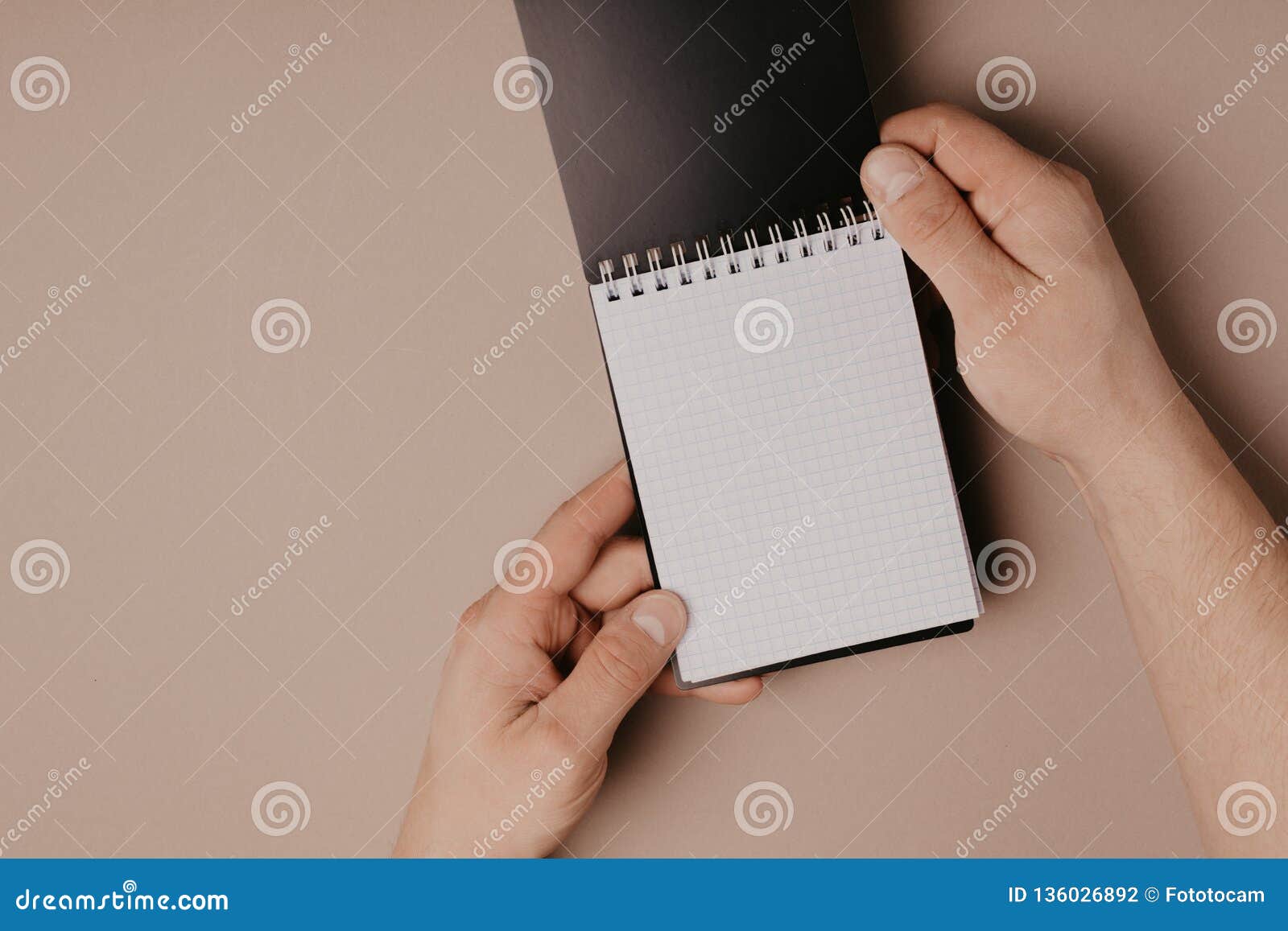 Hand Holding Notebook on Gray Background Stock Photo - Image of note ...
