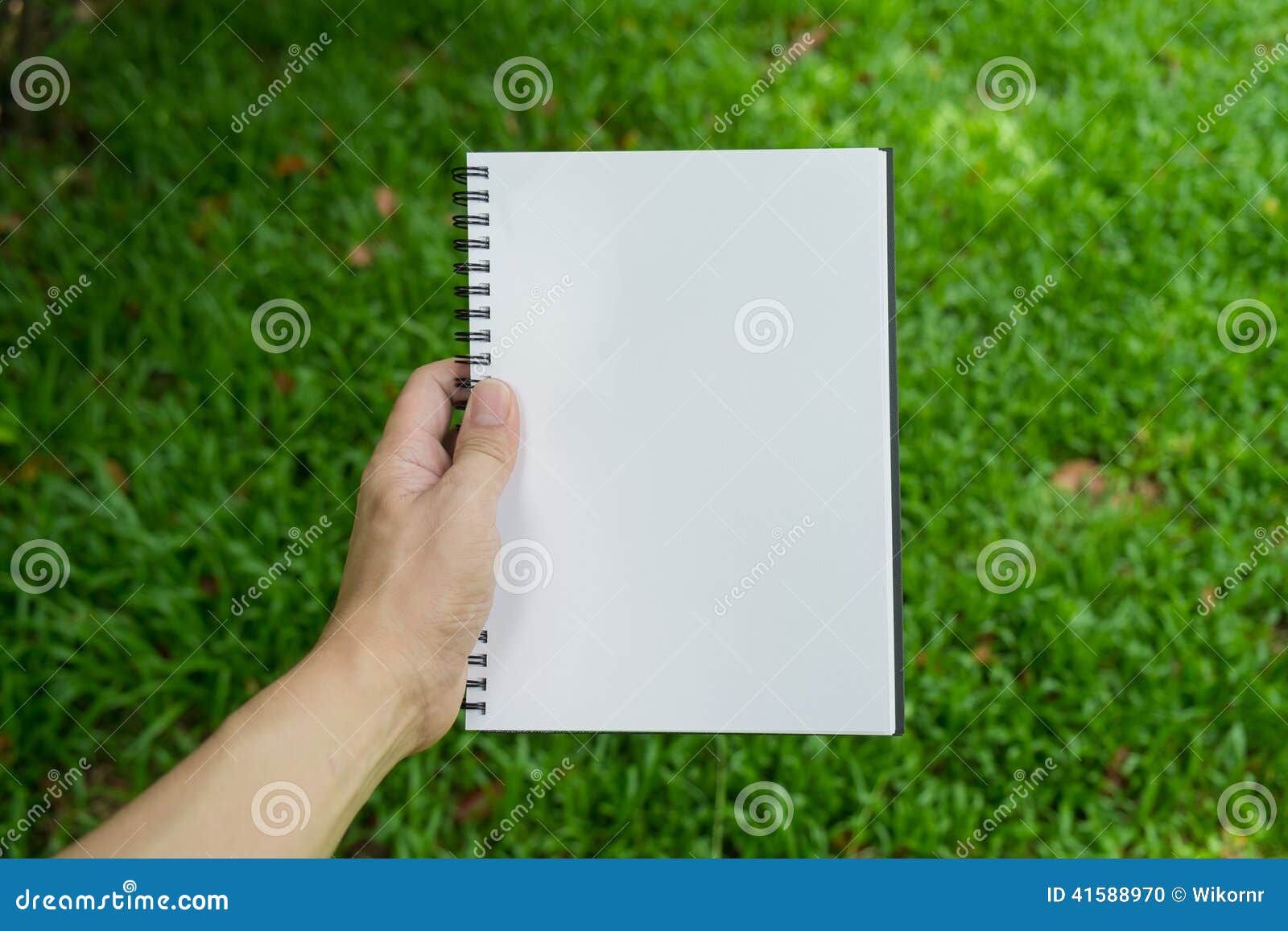 Hand holding notebook stock photo. Image of grass, notepad - 41588970