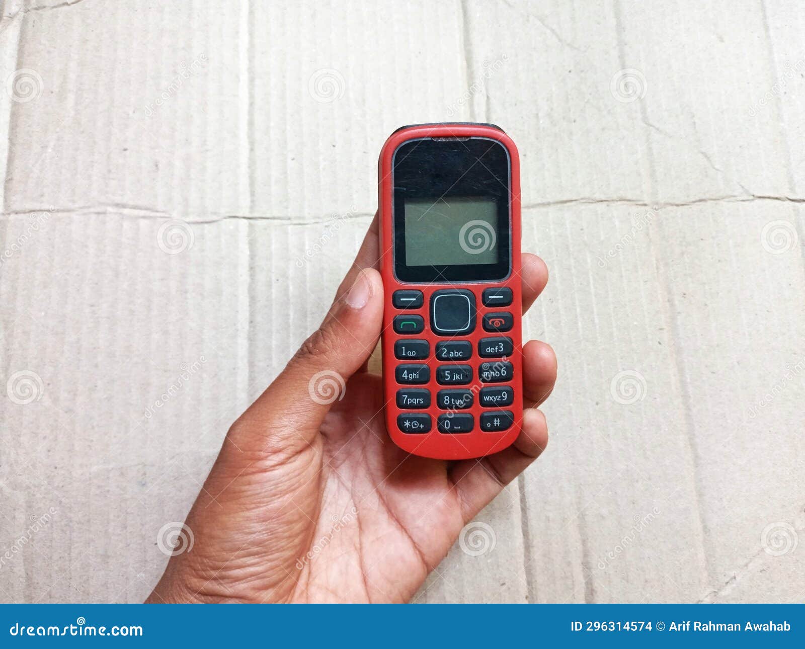 Hand Holding Old Mobile Phone with Texting or SMS Button Keyboard or ...