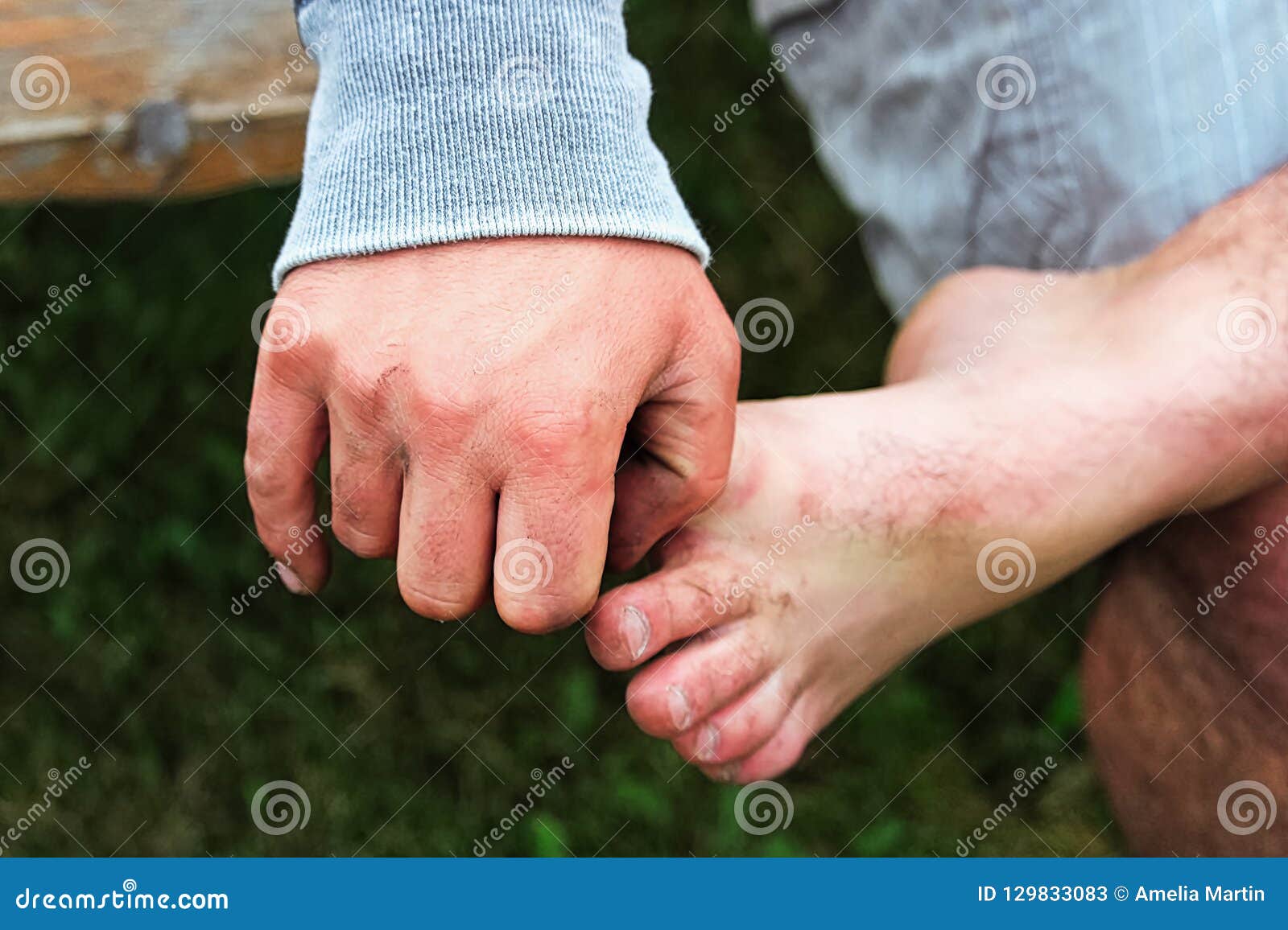 A Hand Holding Onto a Bare Foot while Sitting Stock Image - Image of ...