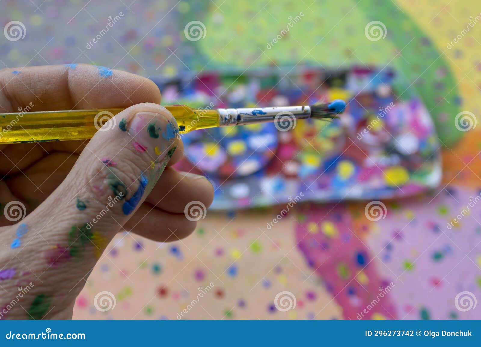 Hand holding paintbrush stock photo. Image of artist - 296273742