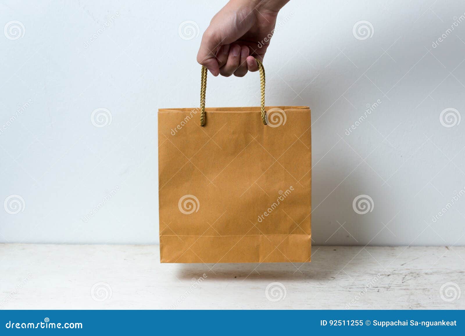 Hand Holding Paper Bag on White Background Stock Image - Image of ...