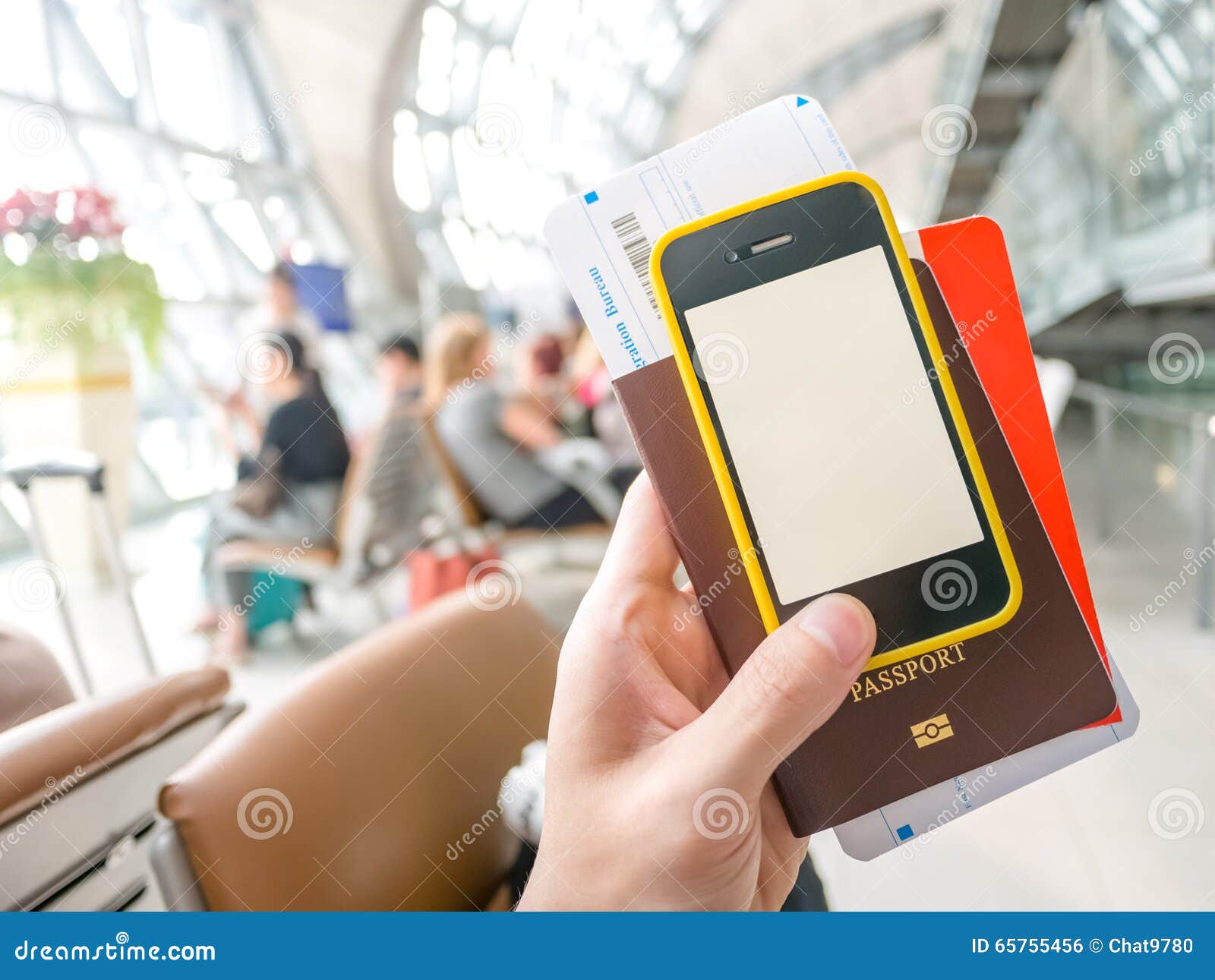 Hand Holding Passport Boarding Pass And Smart Phone In Airport Stock