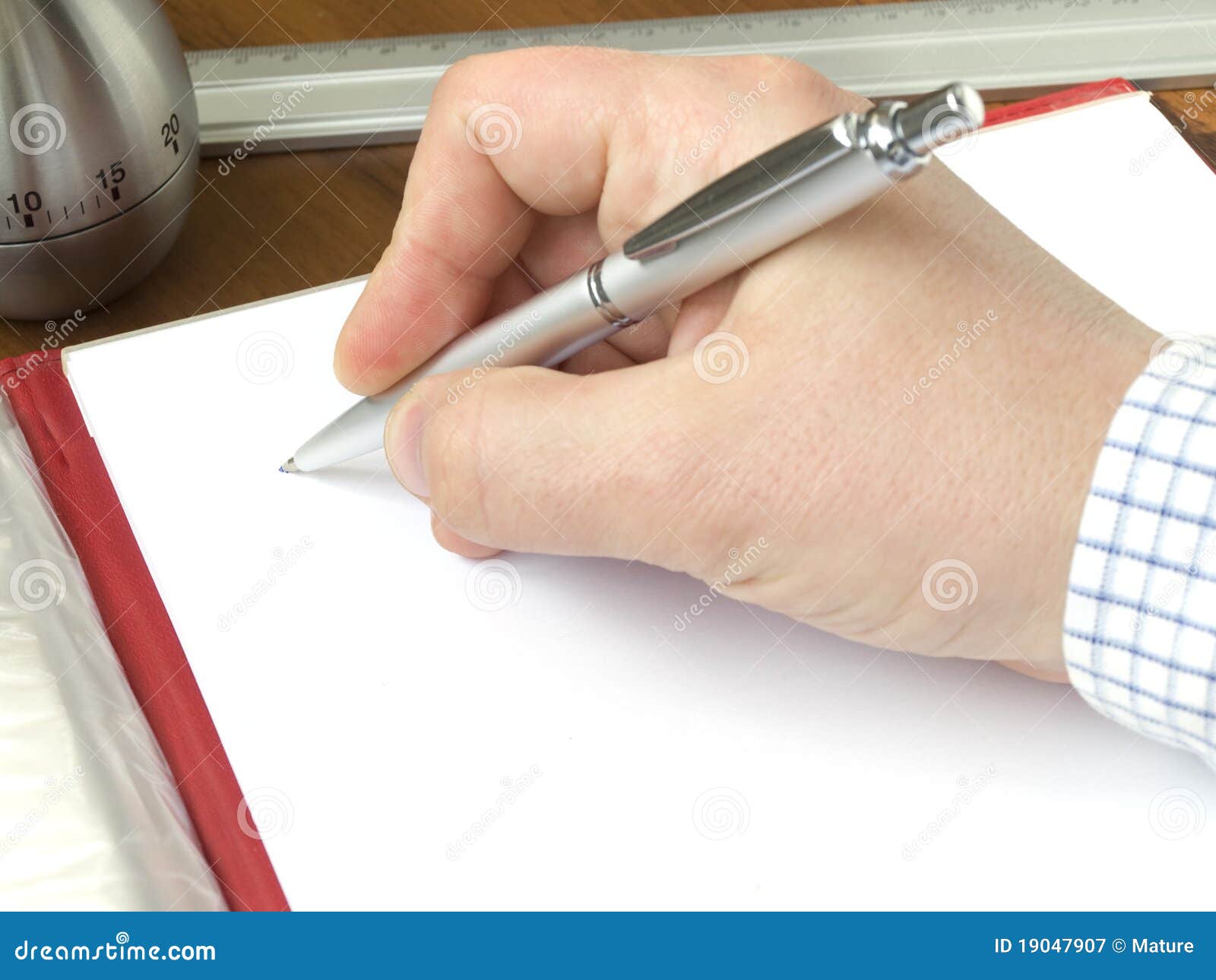 Hand Holding a Pen and Sheet of a Paper Laying on Stock Image - Image ...