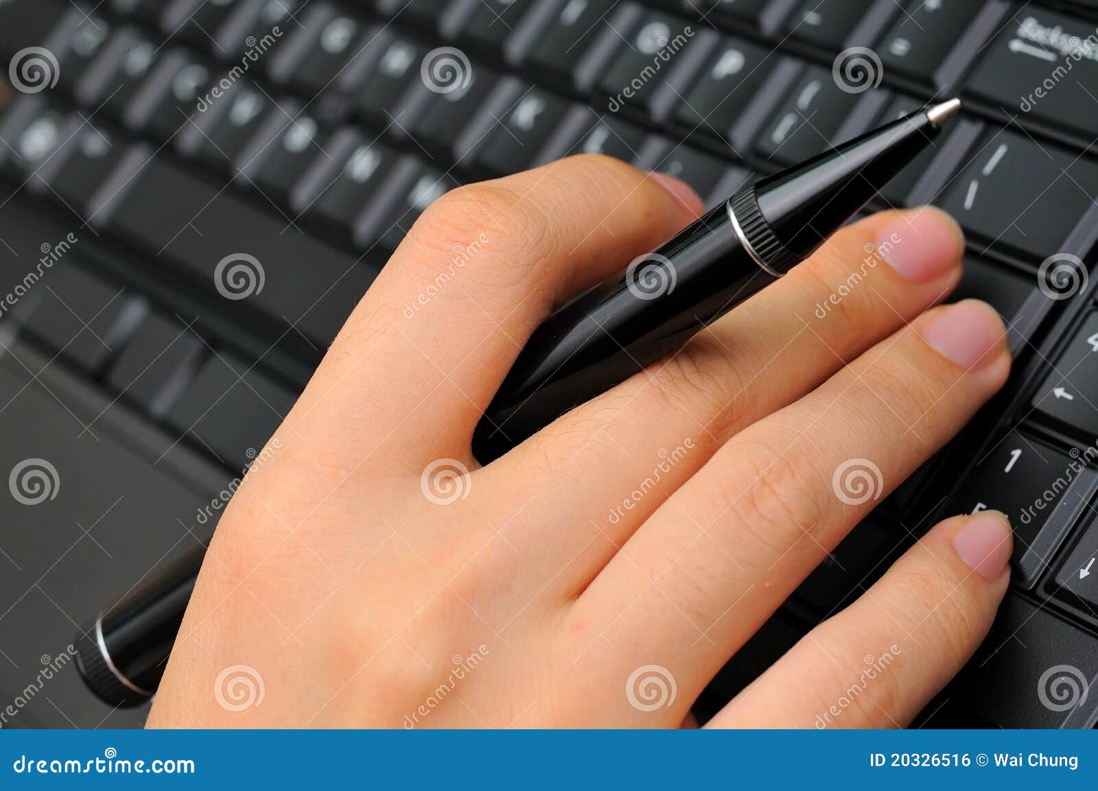 Hand Holding Pen and Typing Stock Photo - Image of finger, type: 20326516