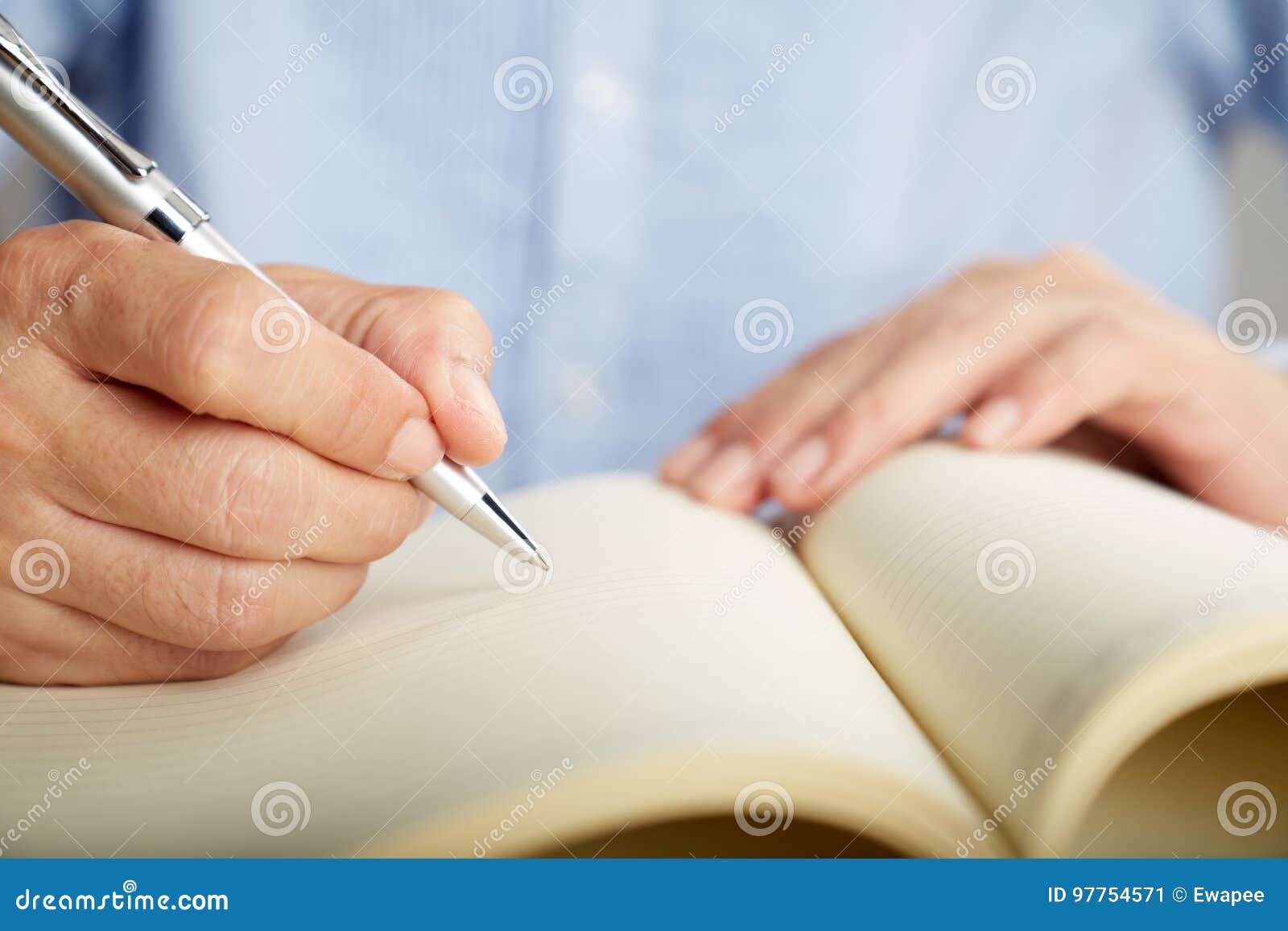 Hand Holding a Pen and Writing in Notebook,Close Up Stock Image - Image ...