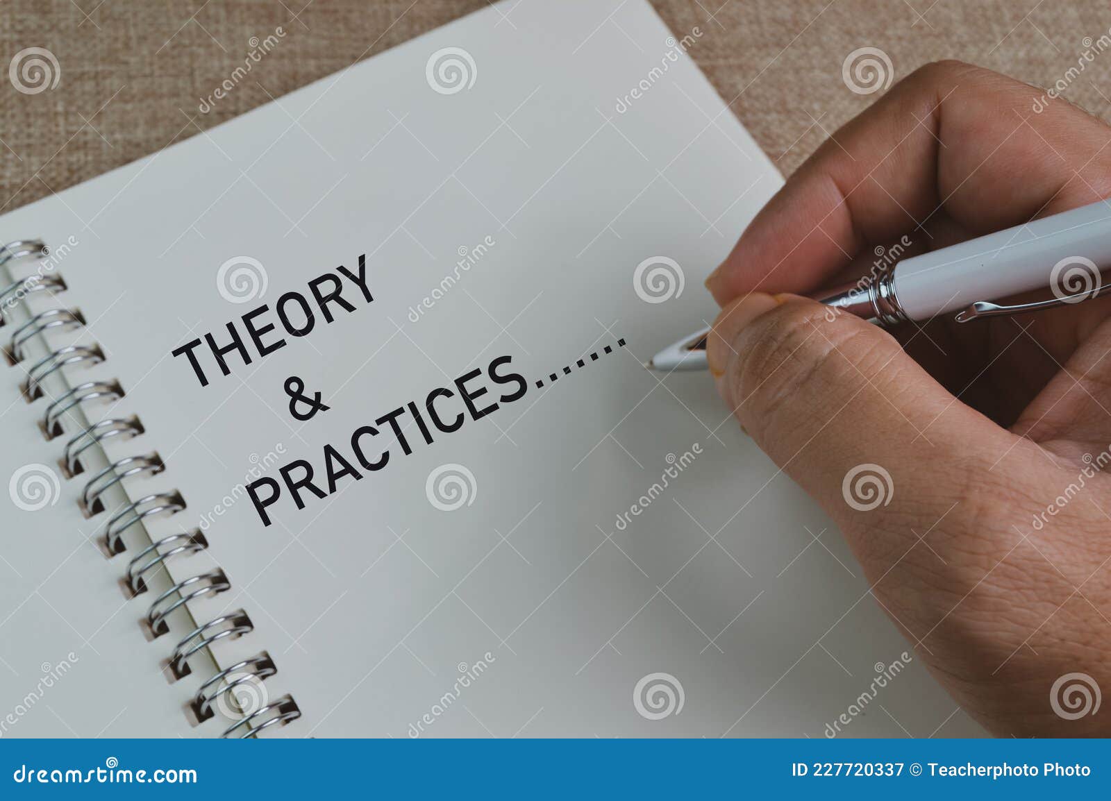 Hand Holding Pen and Writing THEORY and PRACTICES Stock Image - Image ...