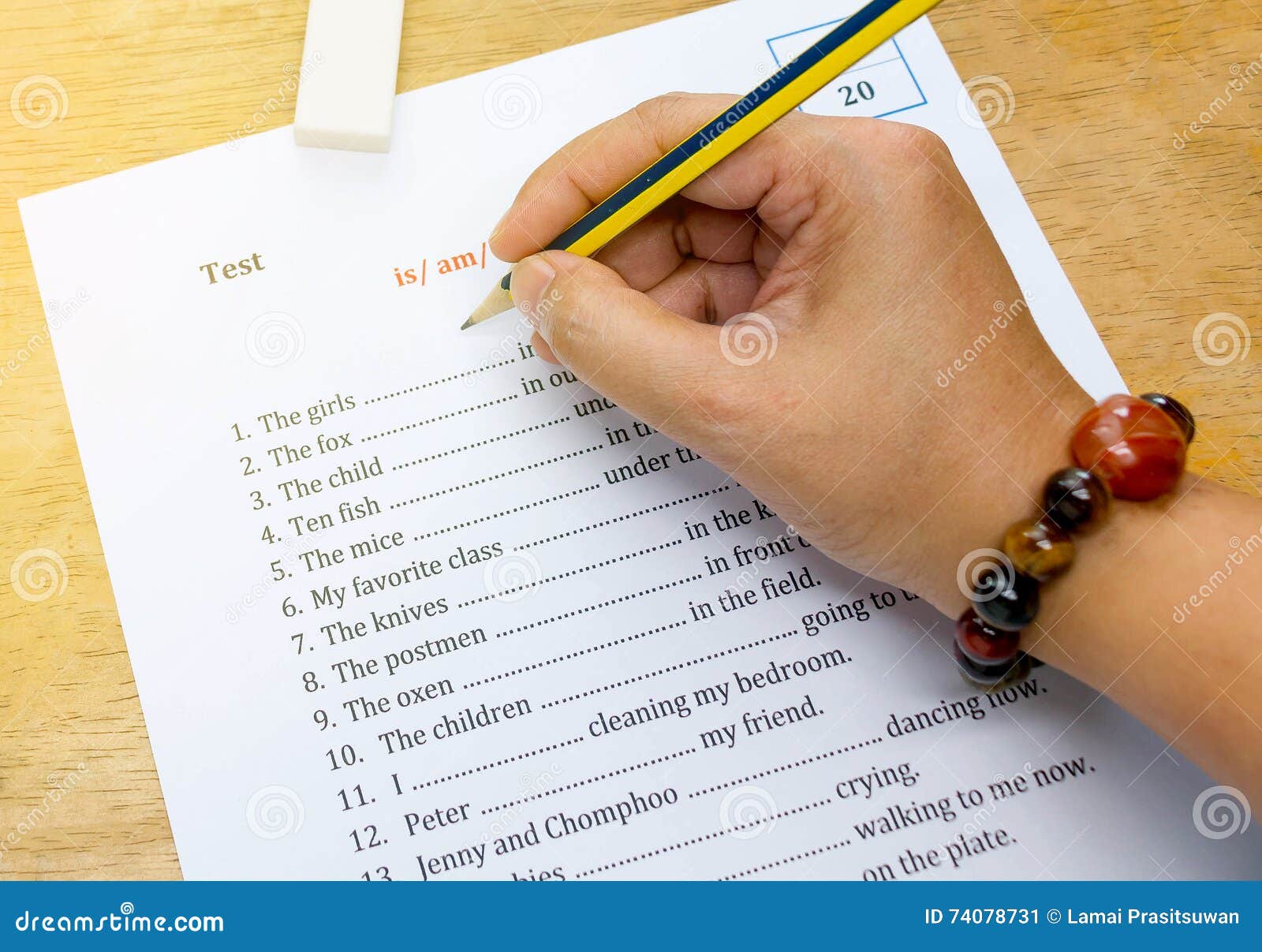 Hand Holding Pencil Over English Test with Gradient Light Stock Image ...