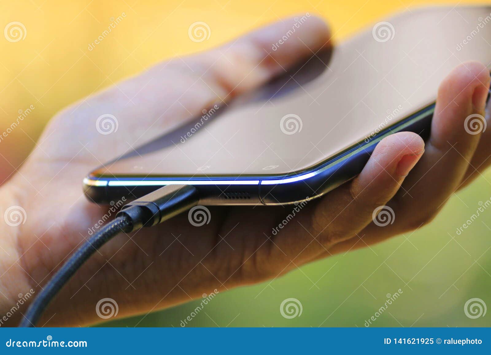 Hand Holding the Phone with the Charging Cable Stock Image - Image of ...