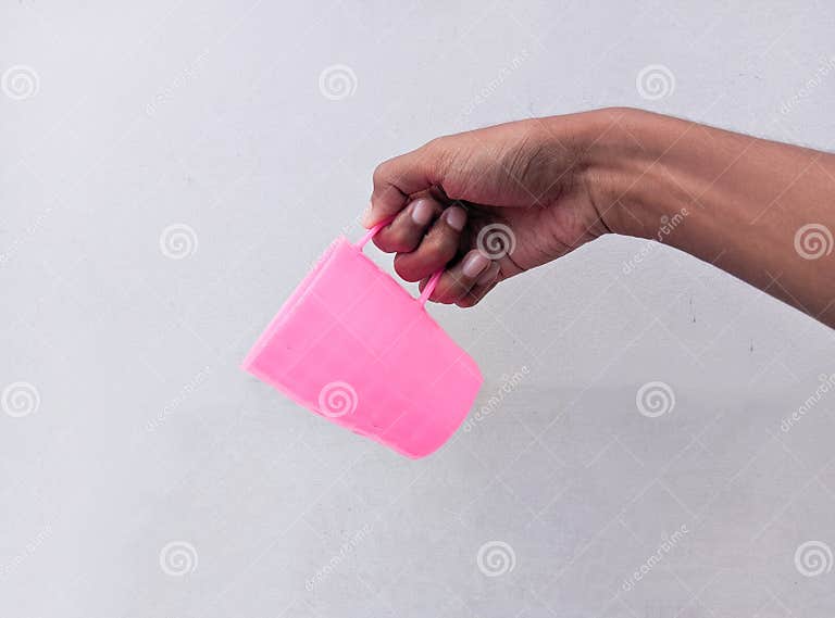 Hand Holding Pink Plastic Cup on White Background. Stock Image - Image ...