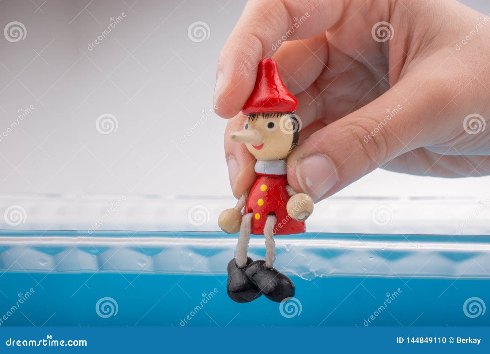 Hand Holding Pinocchio on in Water Stock Photo - Image of doll, funny ...