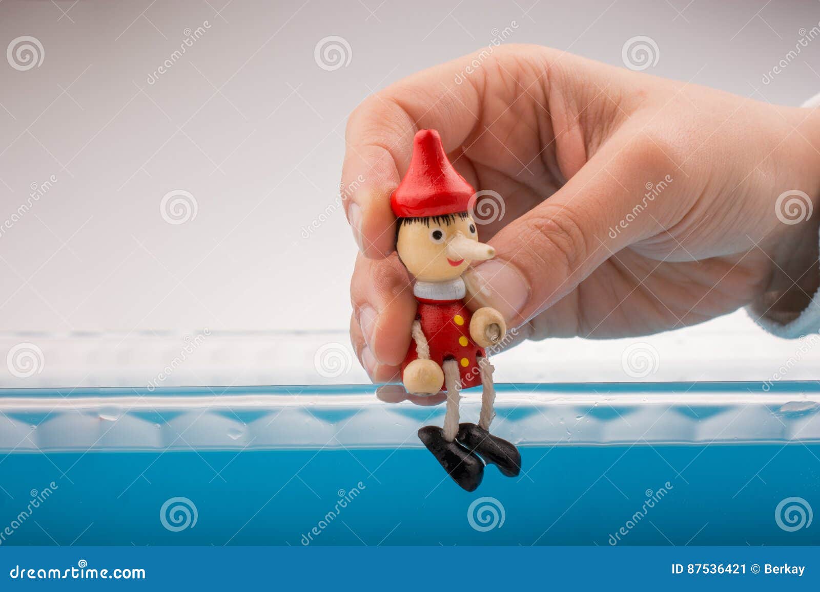 Hand Holding Pinocchio on in Water Stock Image - Image of character ...