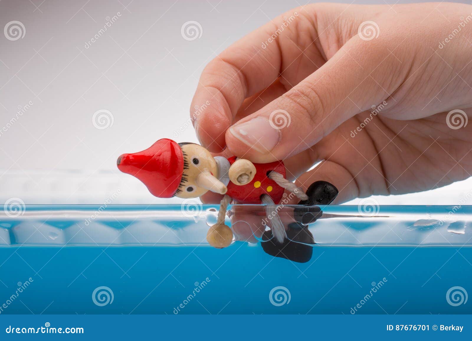 Hand Holding Pinocchio on in Water Stock Image - Image of wooden, funny ...
