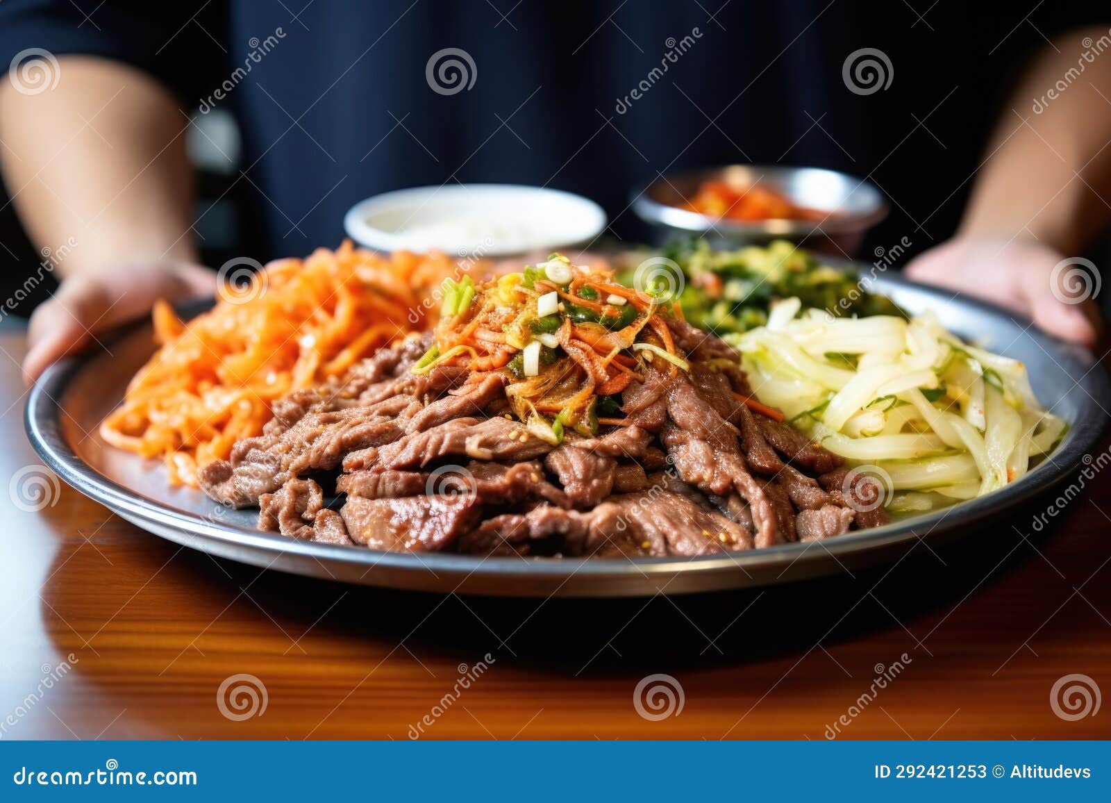 Hand Holding a Plate of Bulgogi with Side Dishes Stock Image - Image of ...