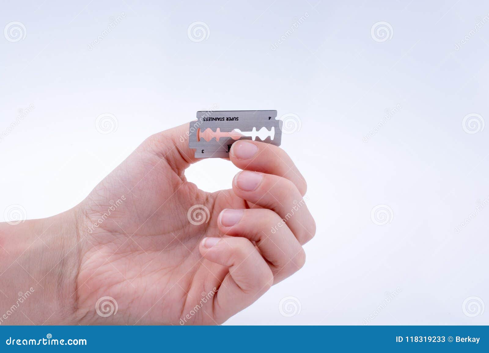Hand holding a razor blade stock image. Image of background - 118319233