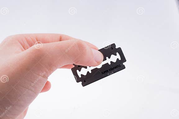 Hand holding a razor blade stock image. Image of steel - 67036489