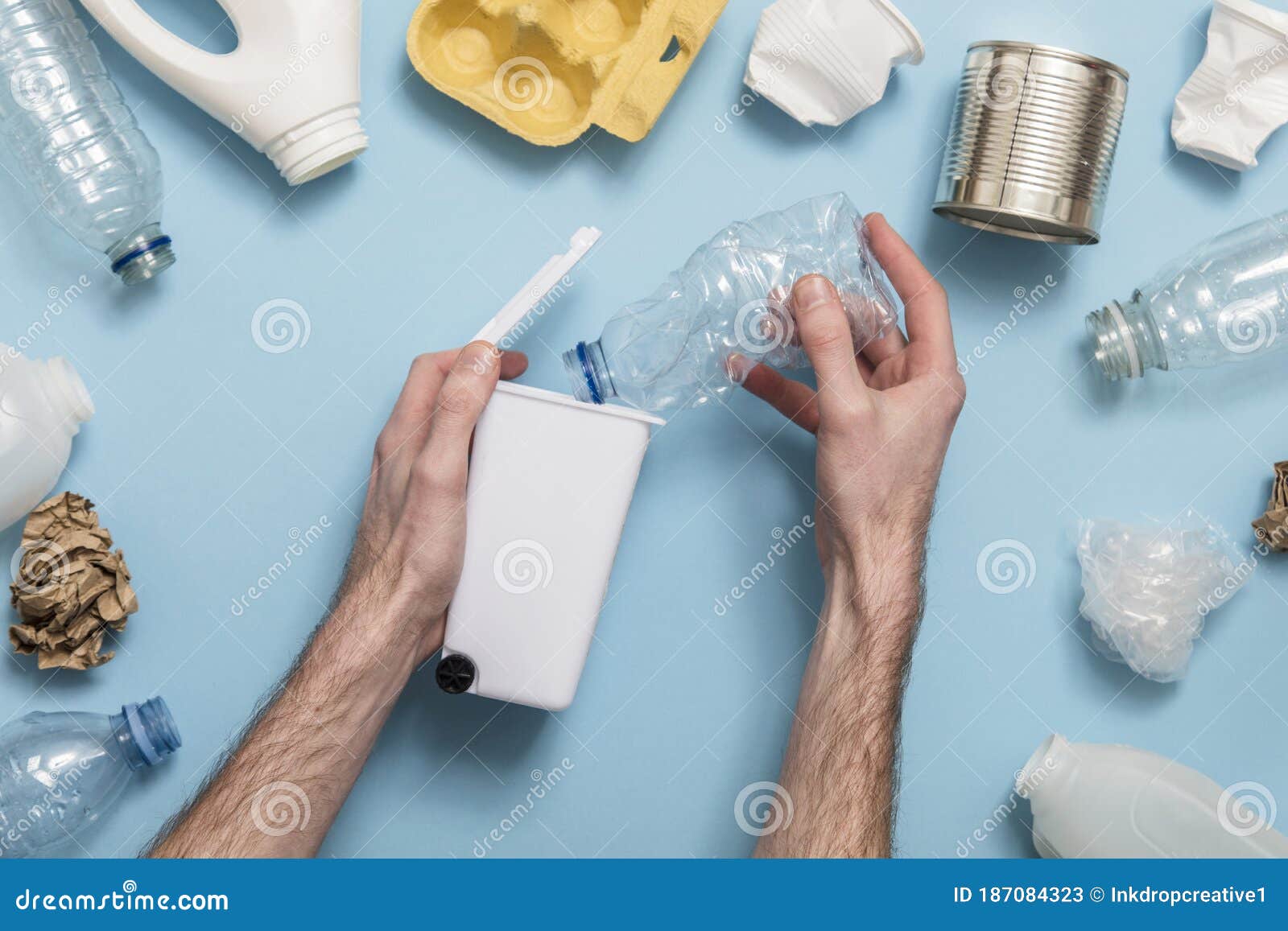 Hand Holding a Recycling Garbage Bin with Lots of Waste Packaging Stock ...