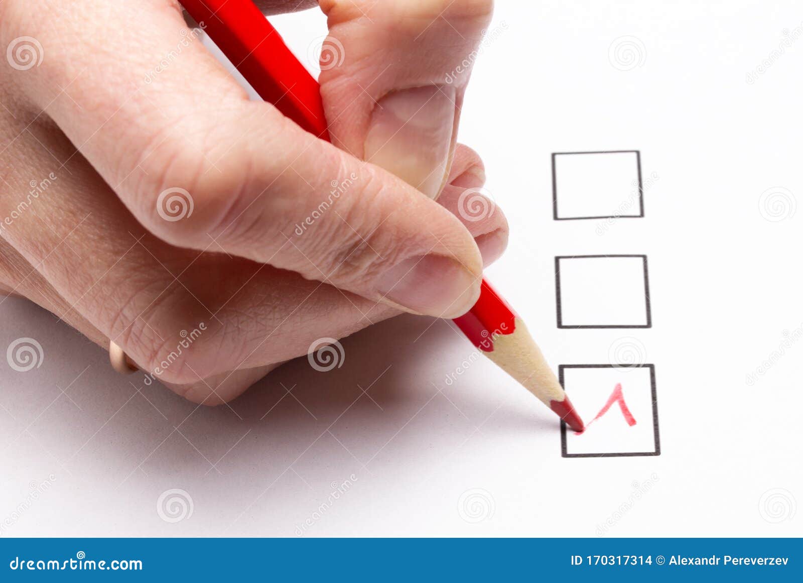 Hand Holding a Red Pencil Makes a Choice in the Voting Questionnaire ...